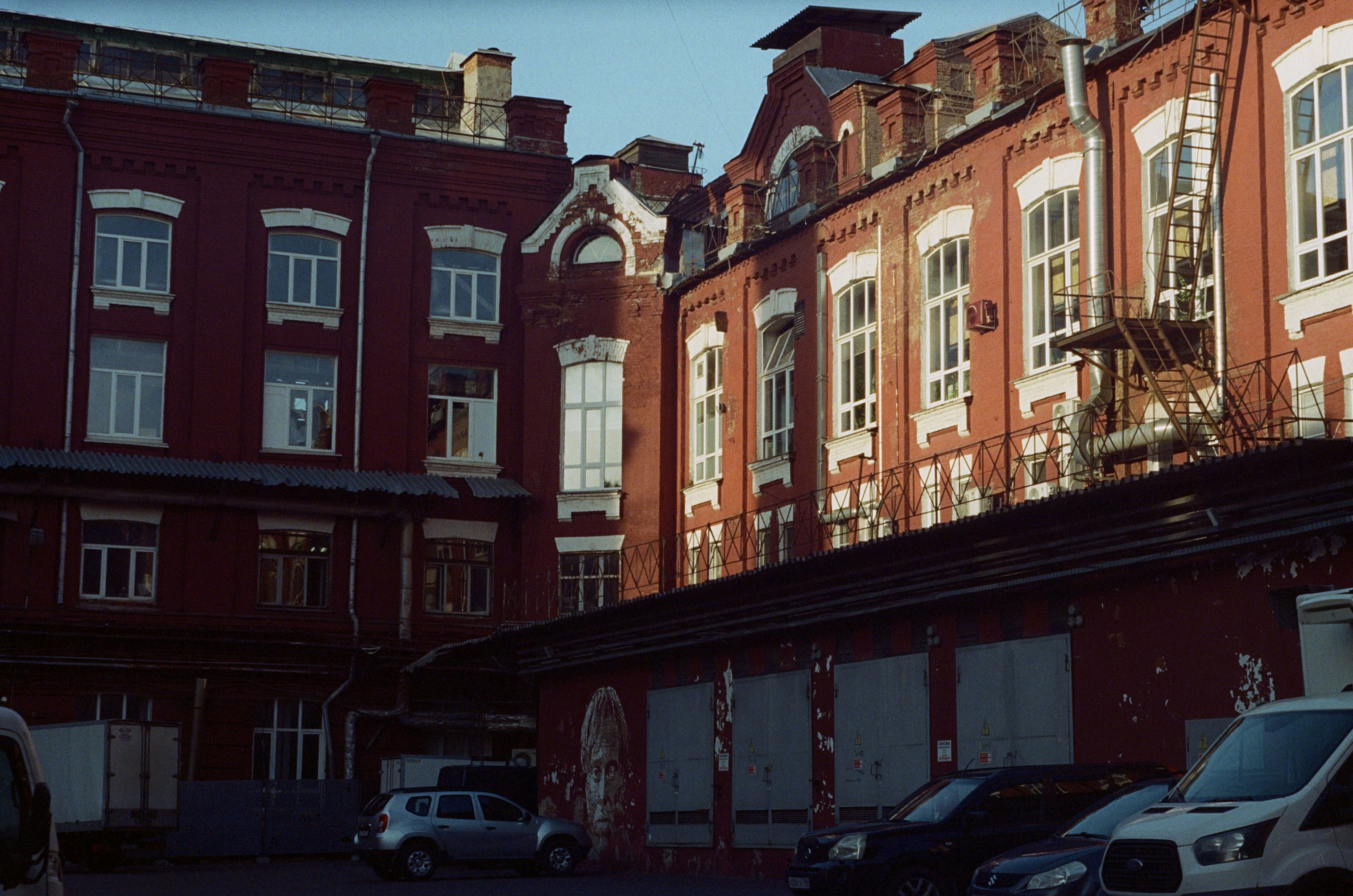 Red Brick Facade at Dusk: A Quiet Urban Wake