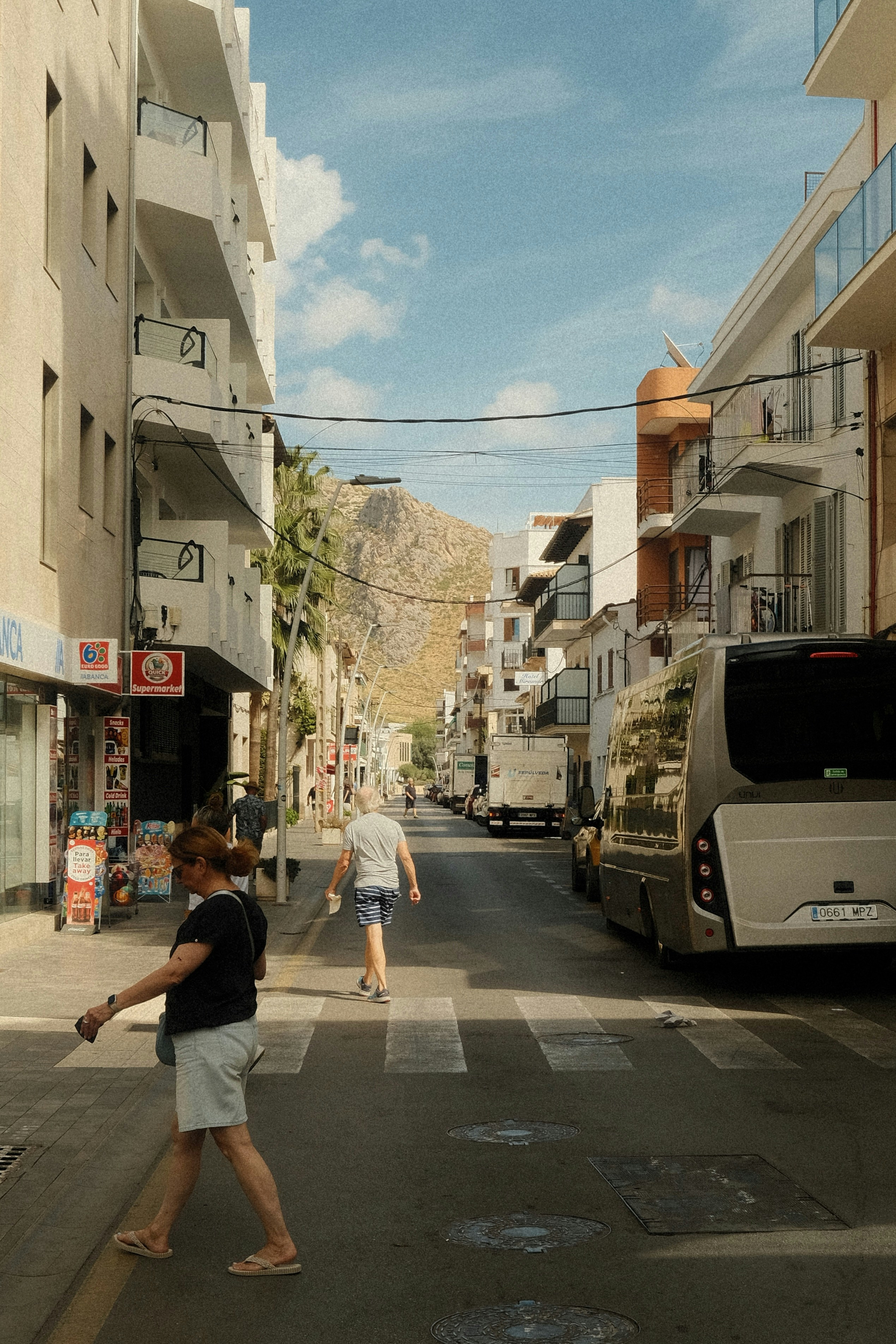 Crosswalk Convergence: Street Life Under a Bright Coastal Sky