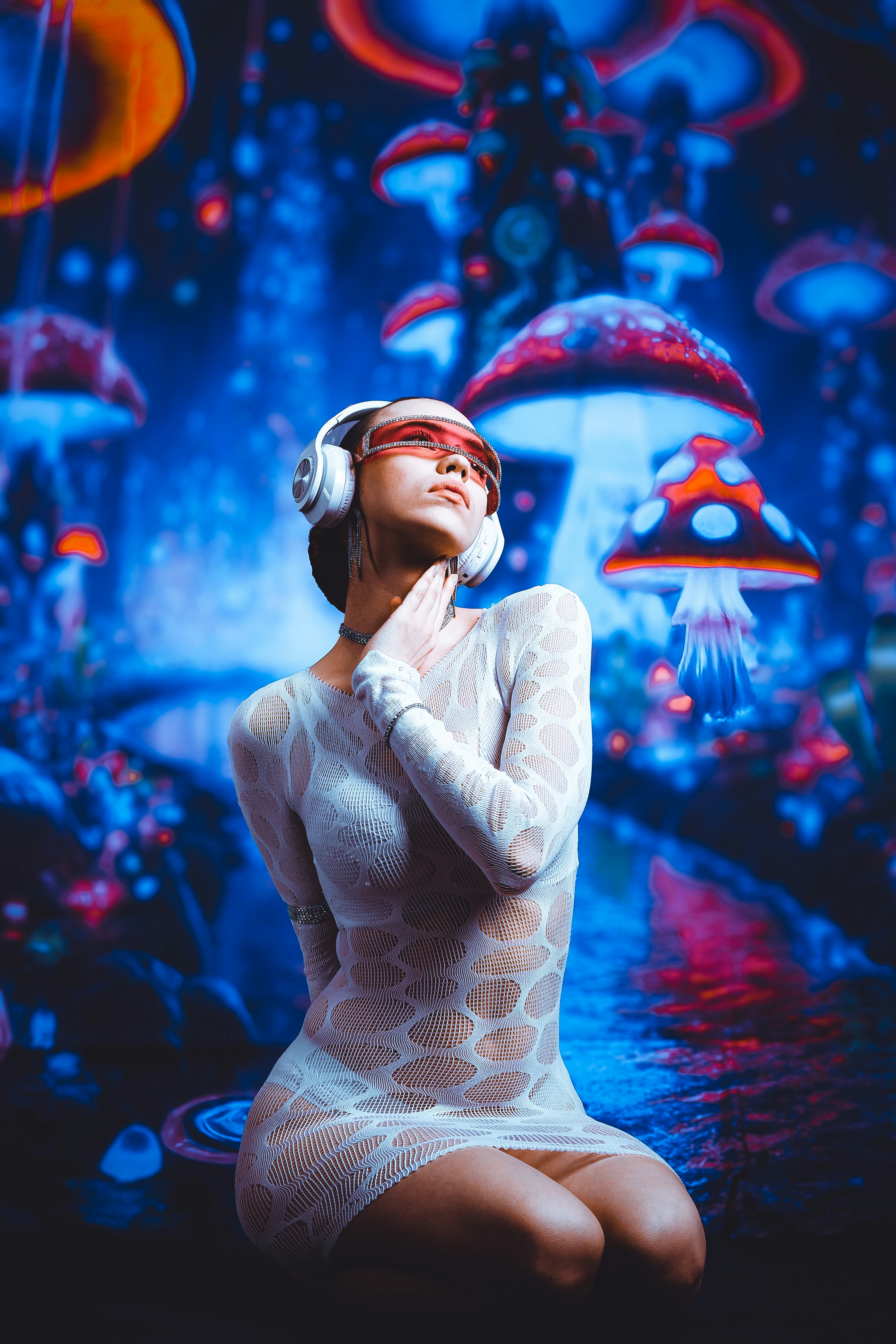 A woman kneels in a surreal, glow-soaked forest of oversized mushrooms, wearing white lace and large headphones, her gaze lifted as if listening to the surreal ambiance.