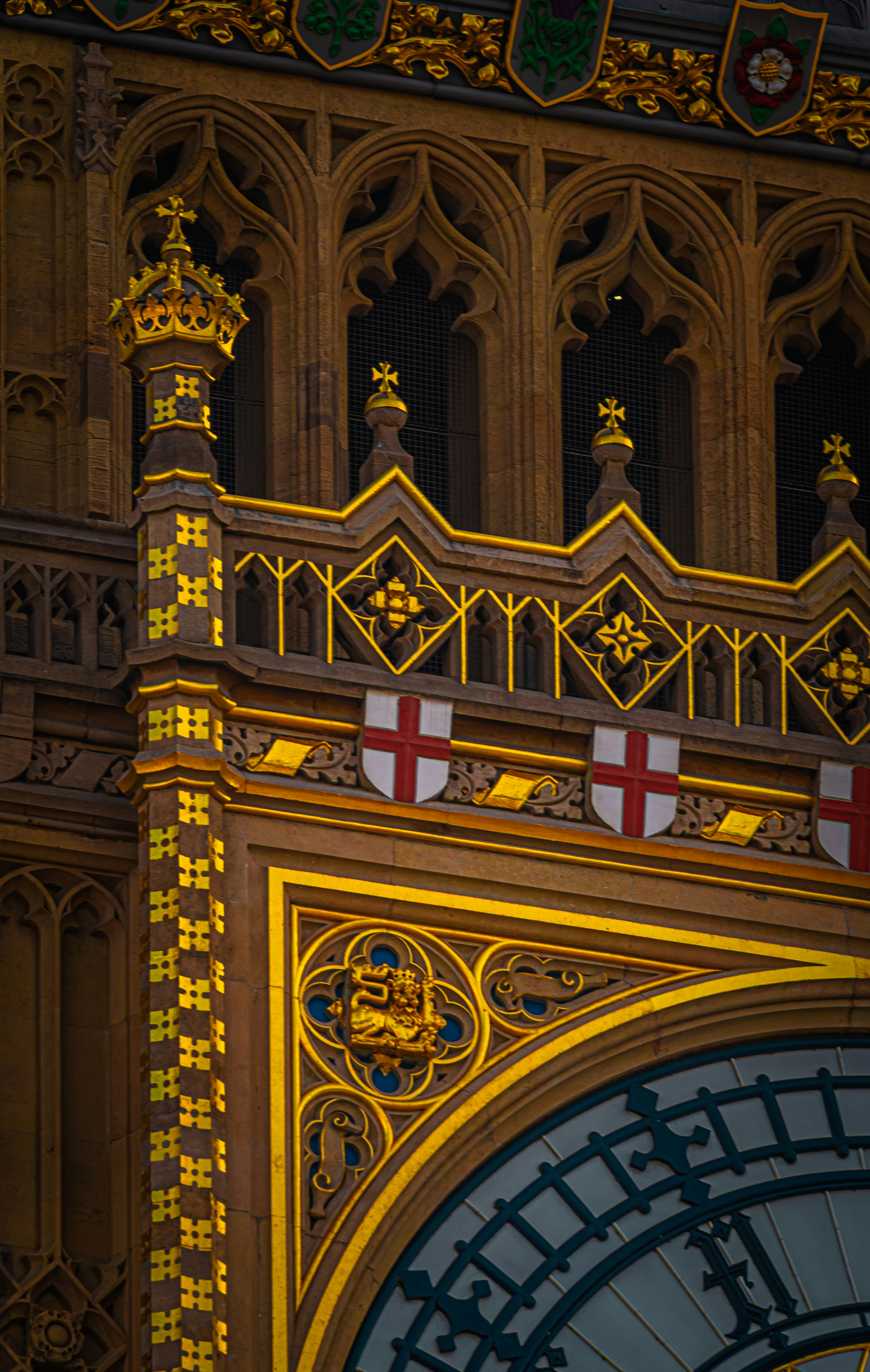 Gilded Gothic Facade: Clock and Crest Above Westminster-esque Arch