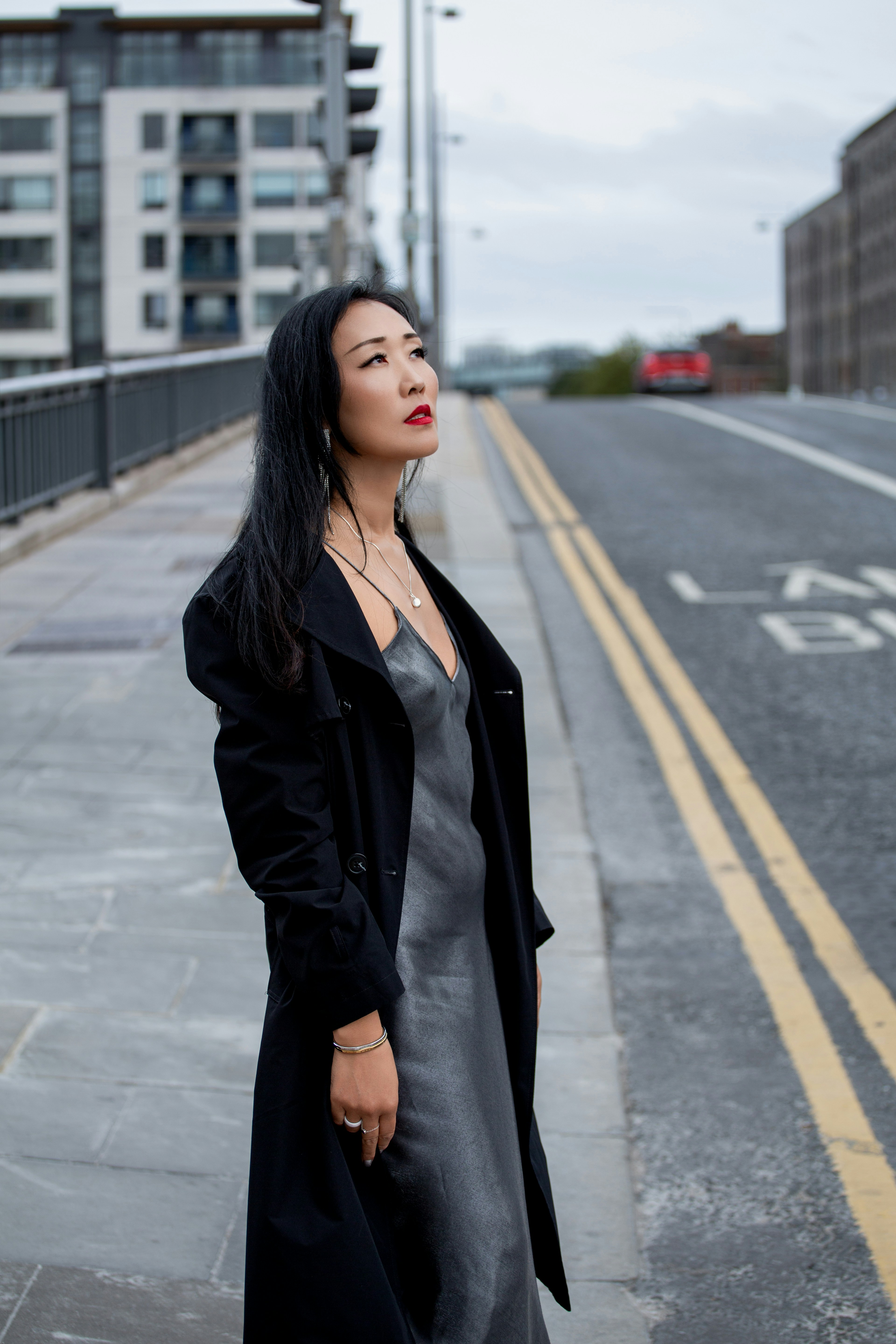 City Lights, Quiet Gaze: A Portrait on a Quiet Street