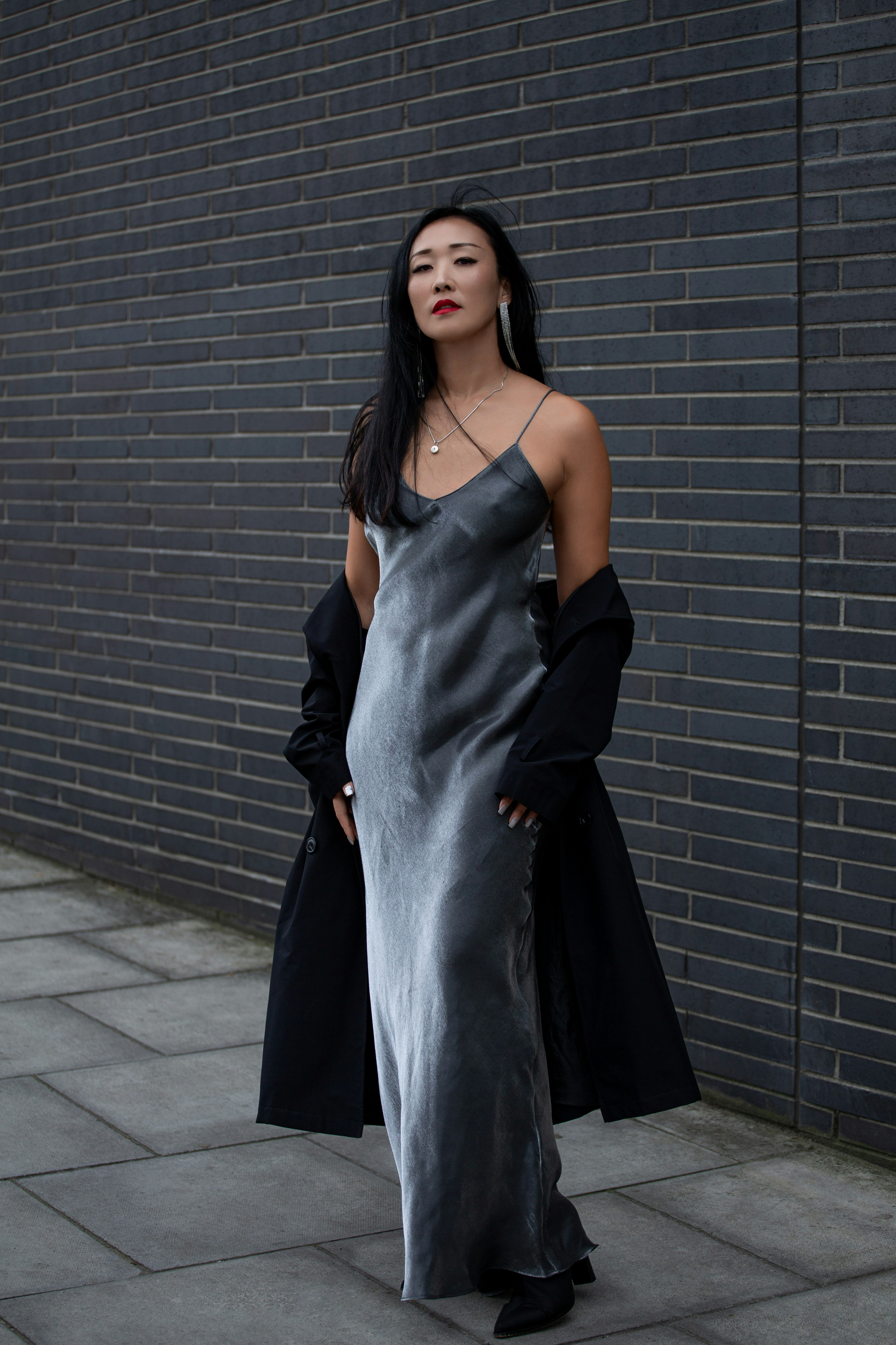 Silvery Slip Glamour Against a Brick Backdrop