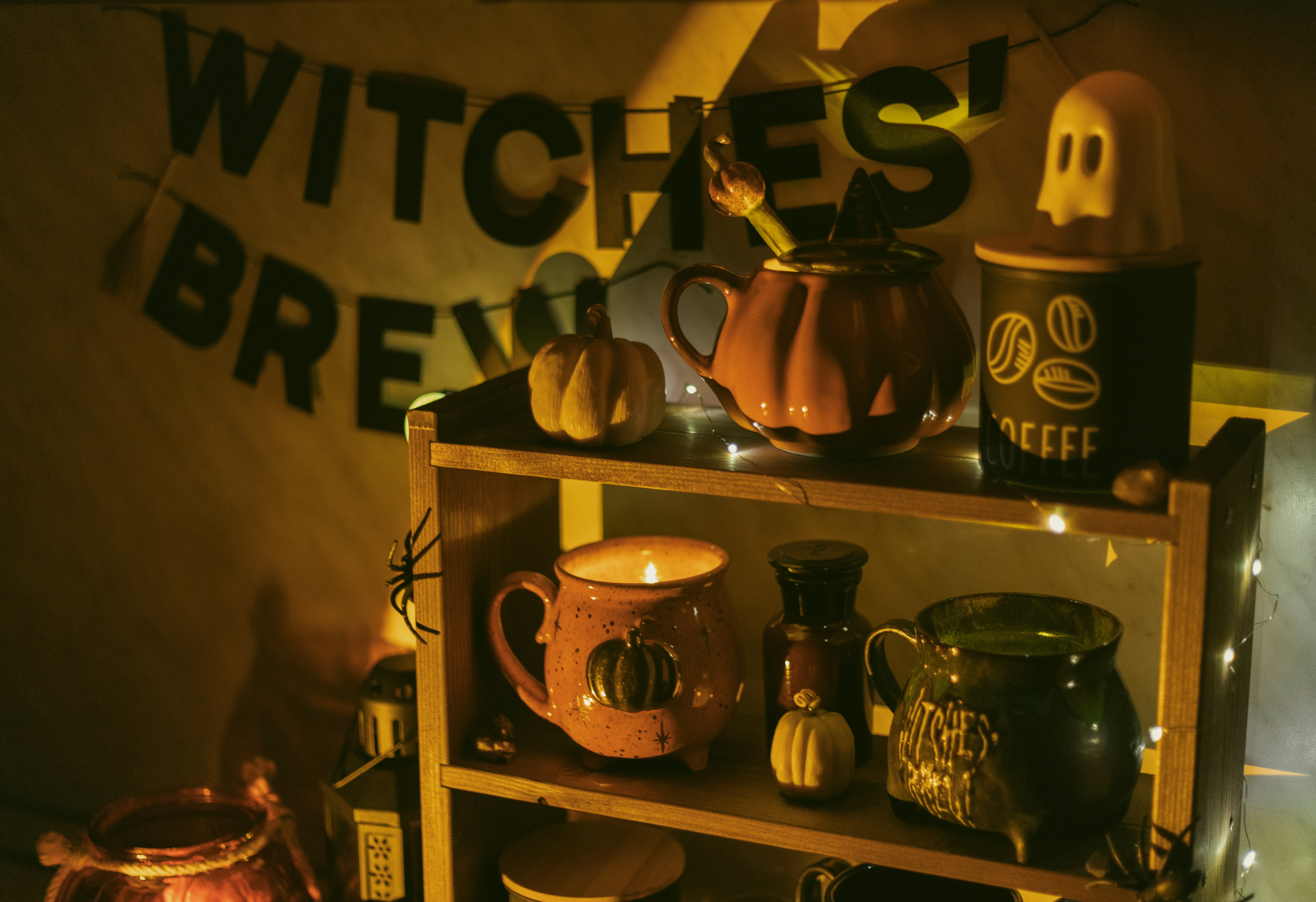 Cozy Halloween Tea Shelf Under Warm String Lights