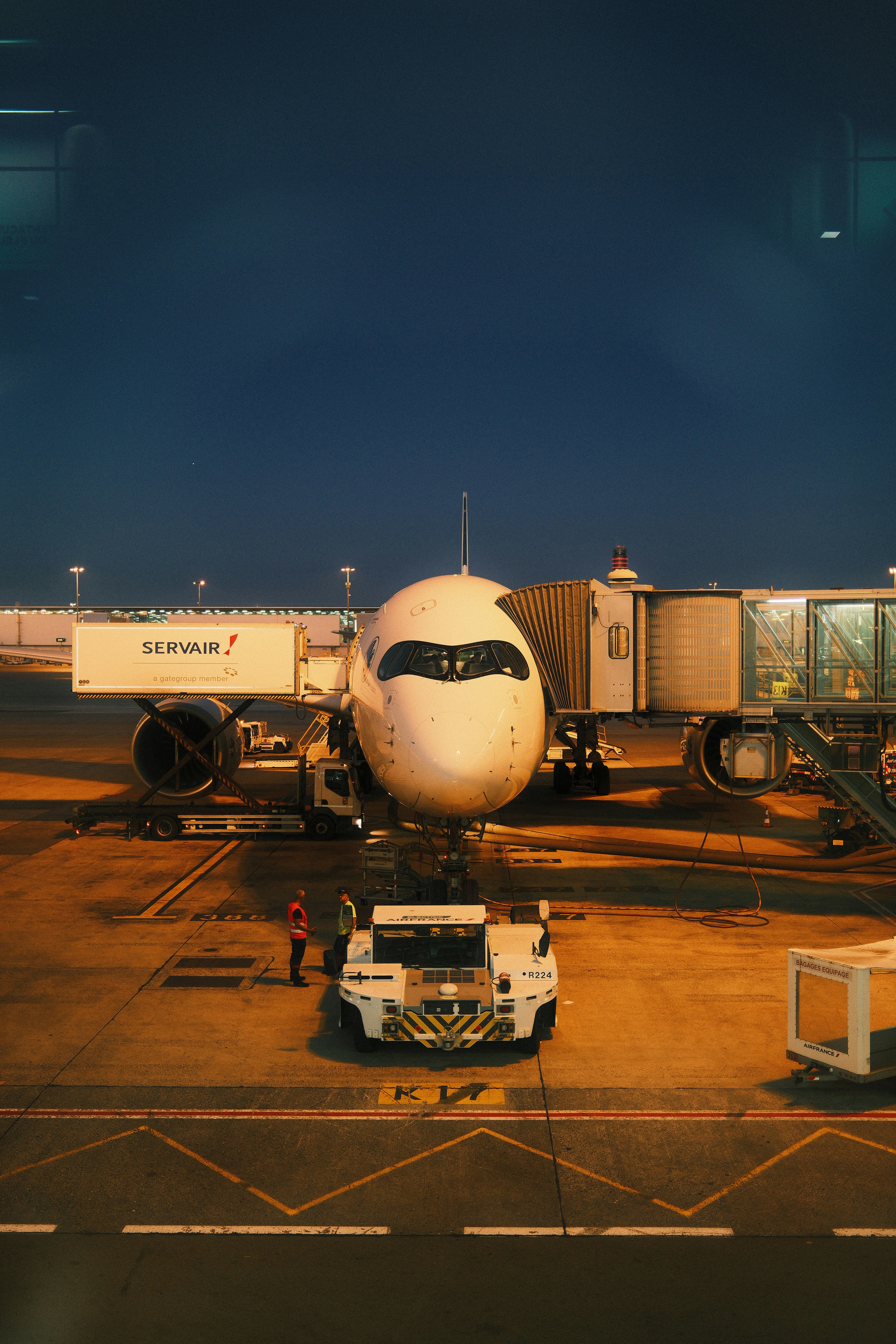 Front-Crowd at Gate: The Nose of the Jet, Ground Crew in Shadow