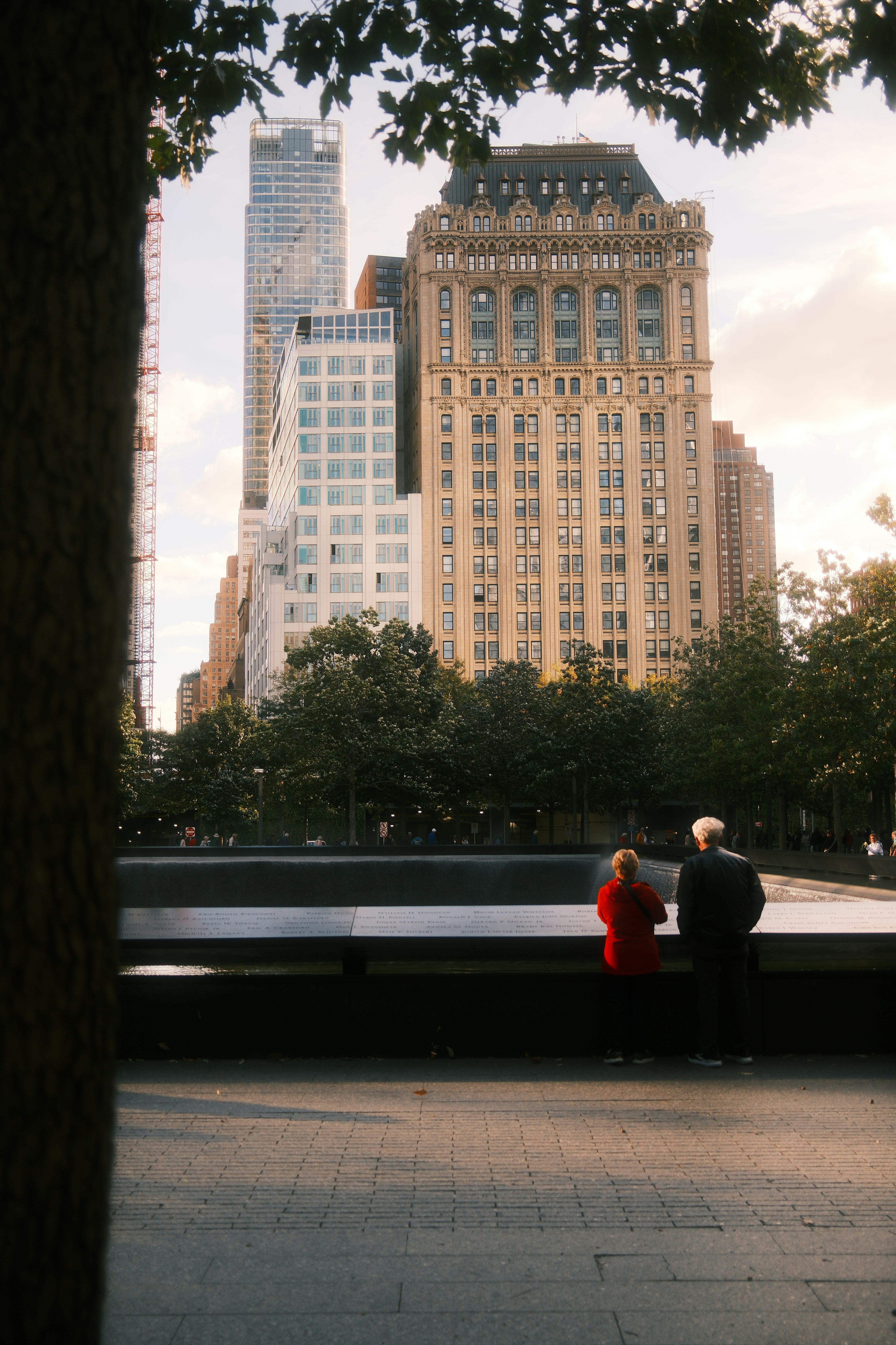 Old-World Tower Among Modern Glass: A Moment by the City Reflecting on the River