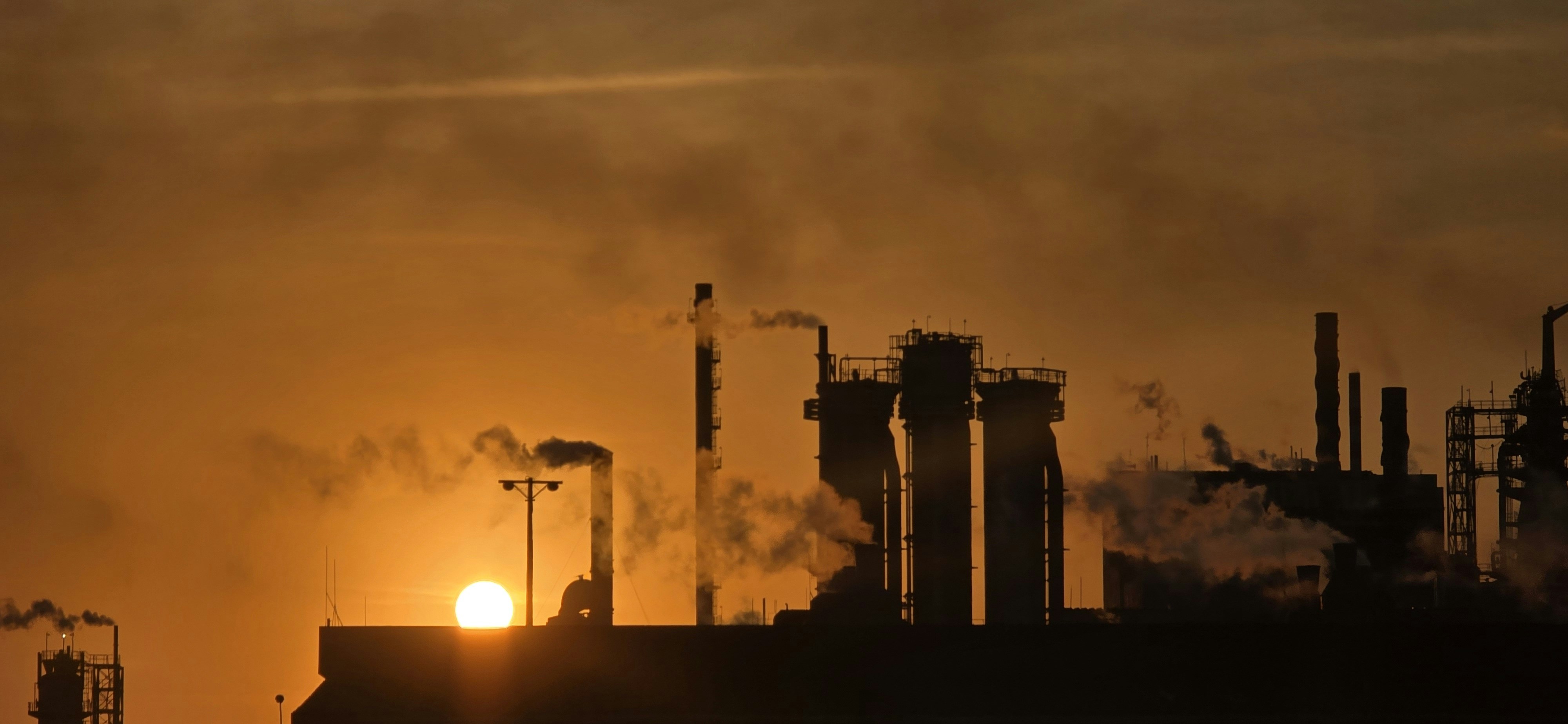 Sunset Flame: A Factory Silhouette Basking in Golden Industrial Glow