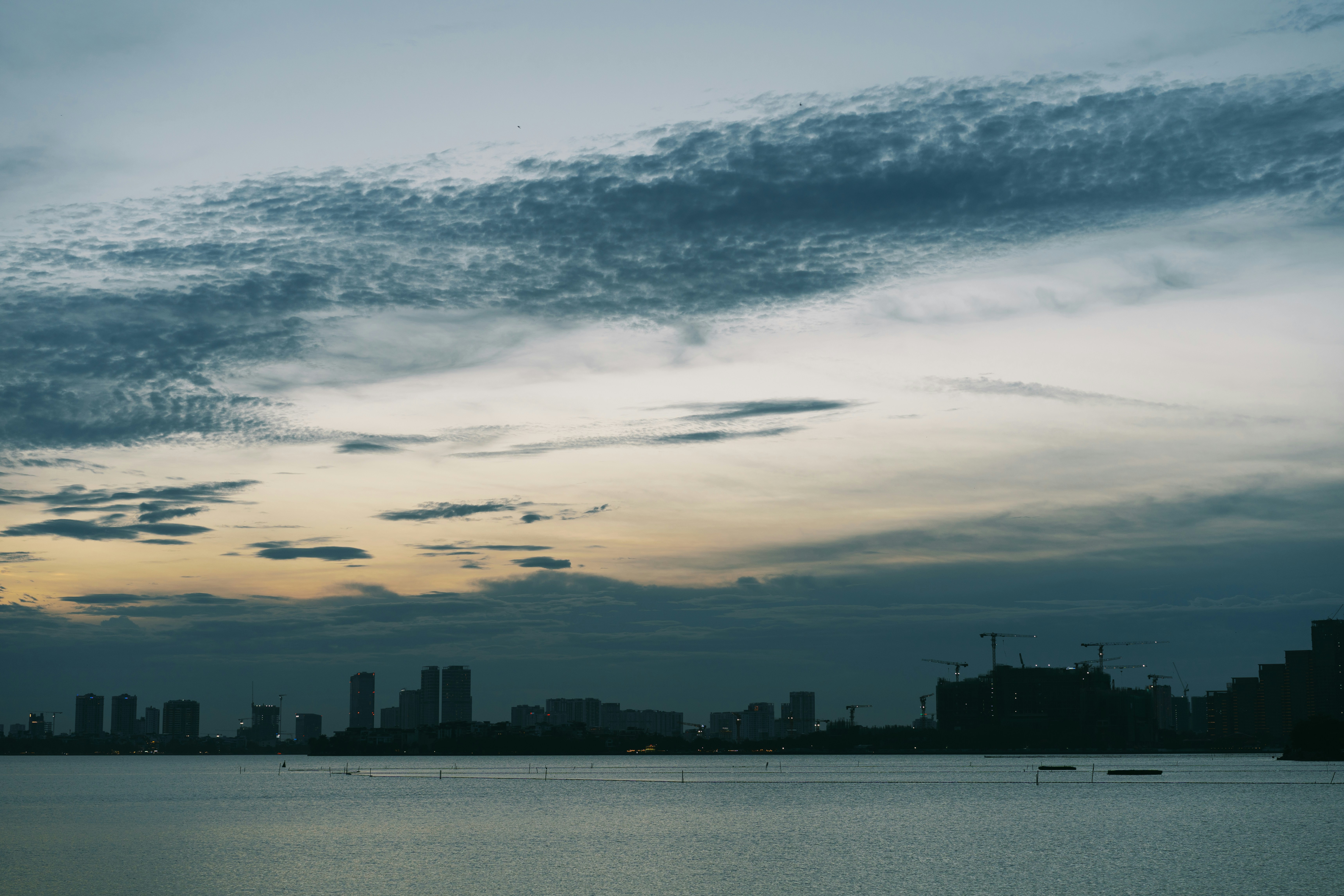 Dusk Over the Quiet Waterfront: A City Silhouette at Calm Blue Hour