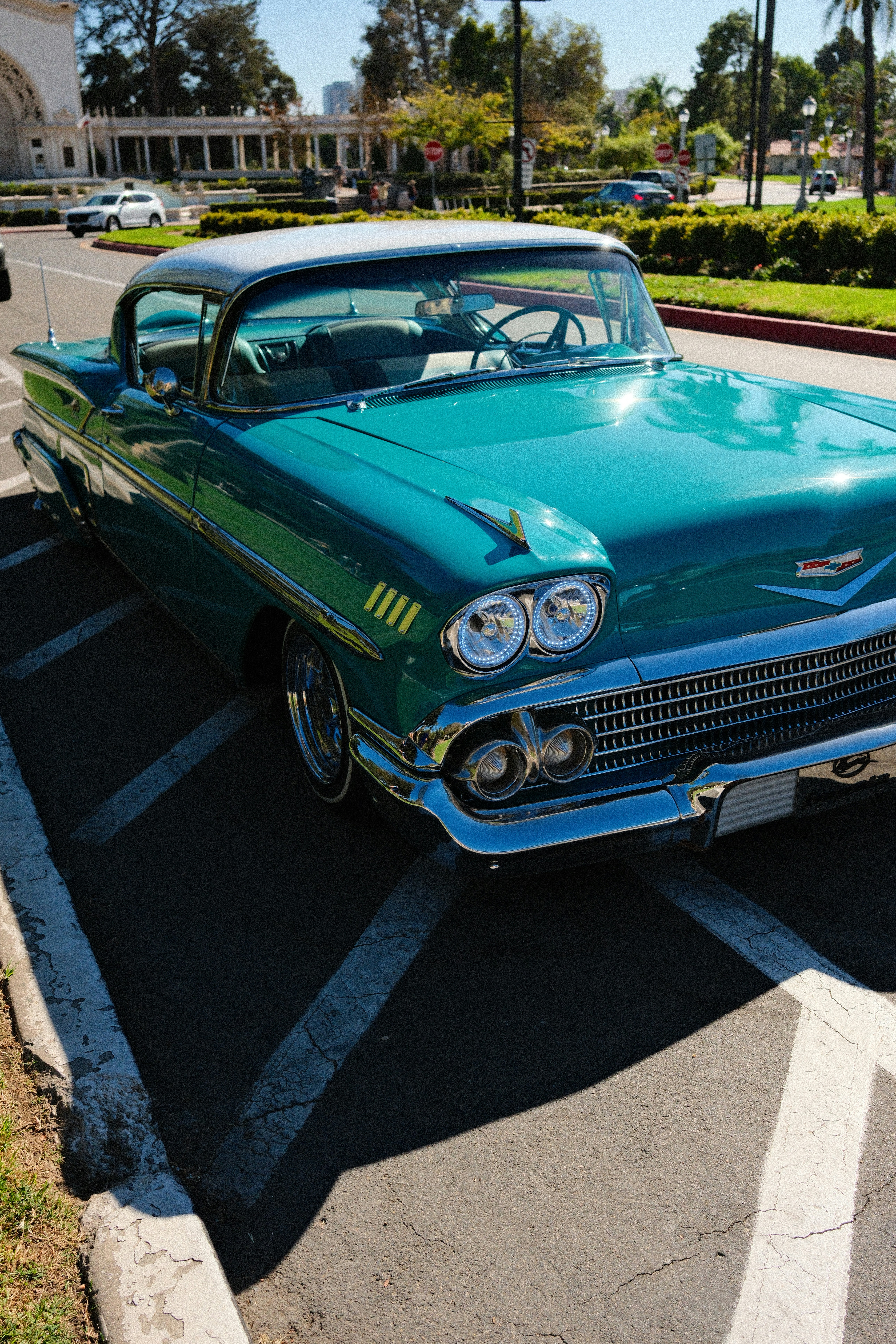 Turquoise Classic: A gleaming vintage Chevrolet guards the parking lane