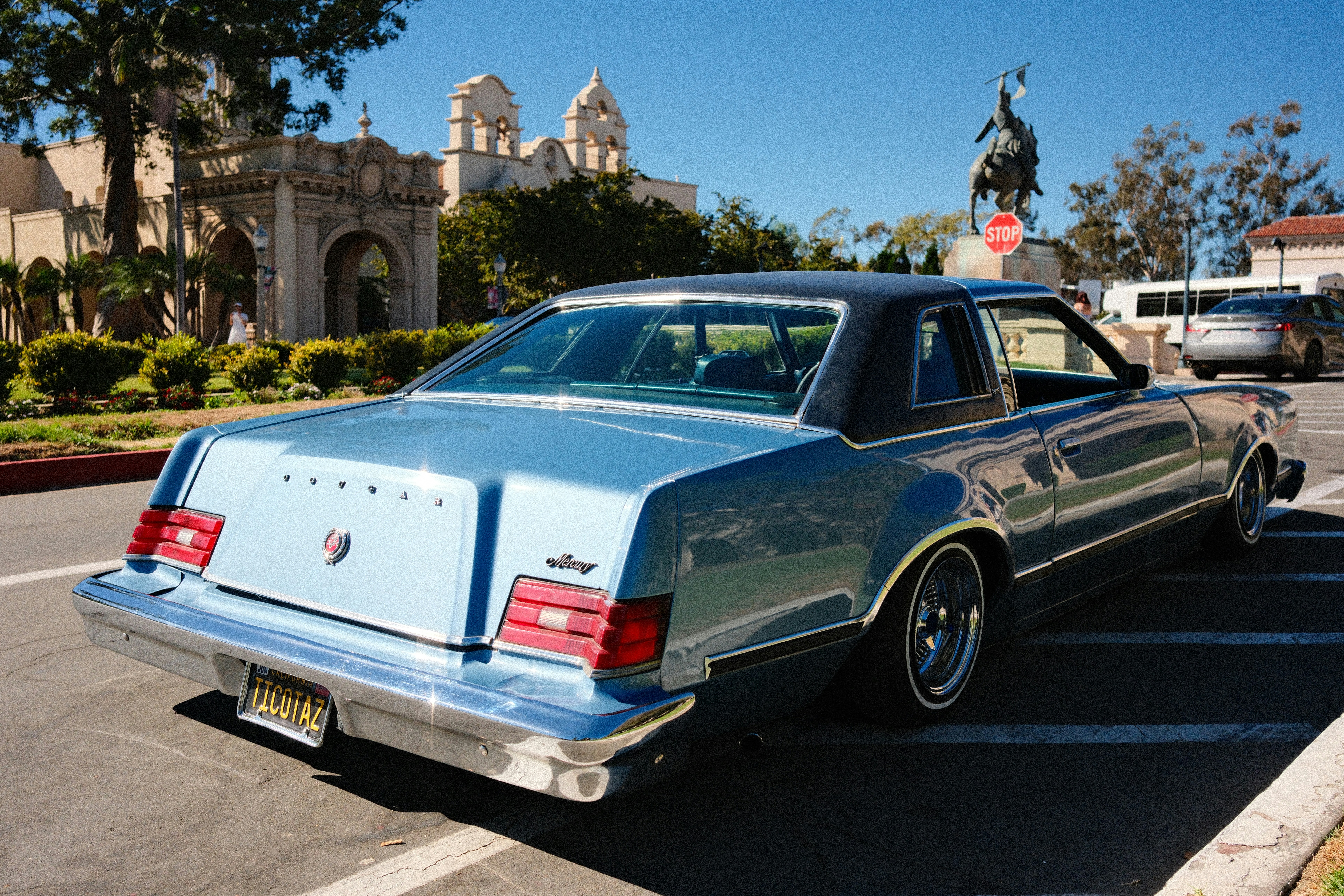 Blue 1970s Cadillac Coupe in Sunlit Parking Lot