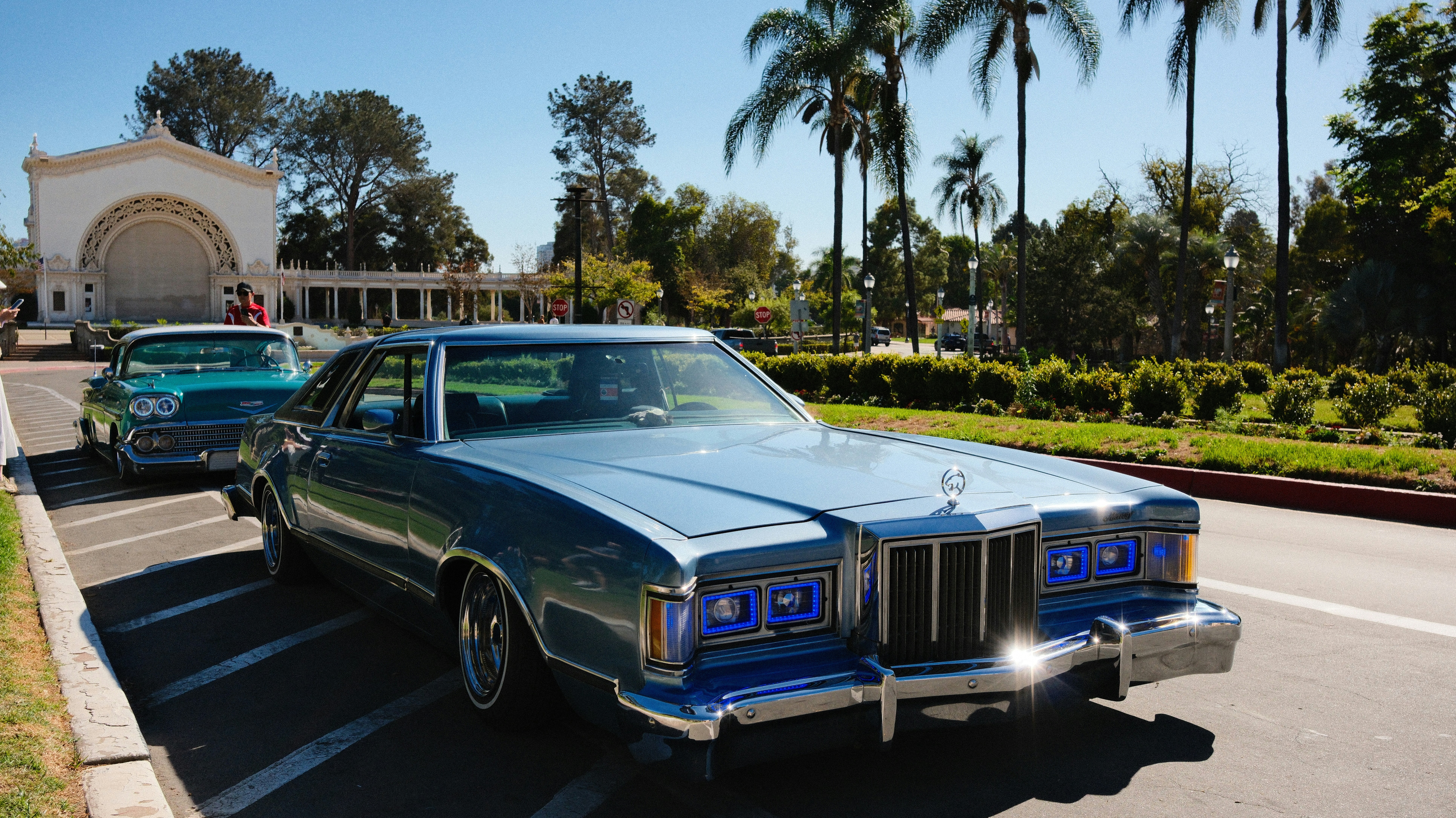 Blue Chrome: A Classic Cadillac Stationed Under Palm Shadows