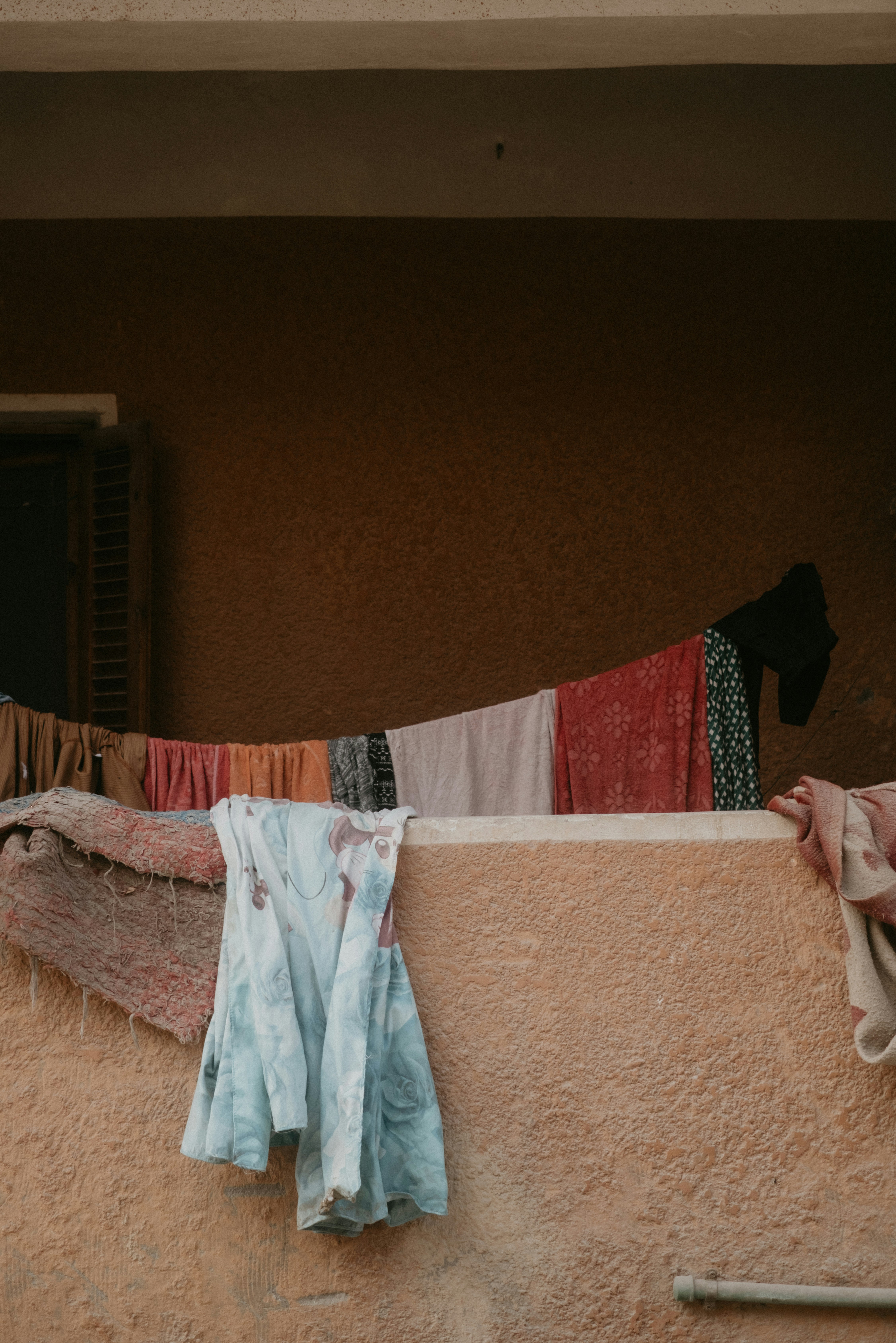 Laundry Line Across a Warm, Textured Terrace Wall