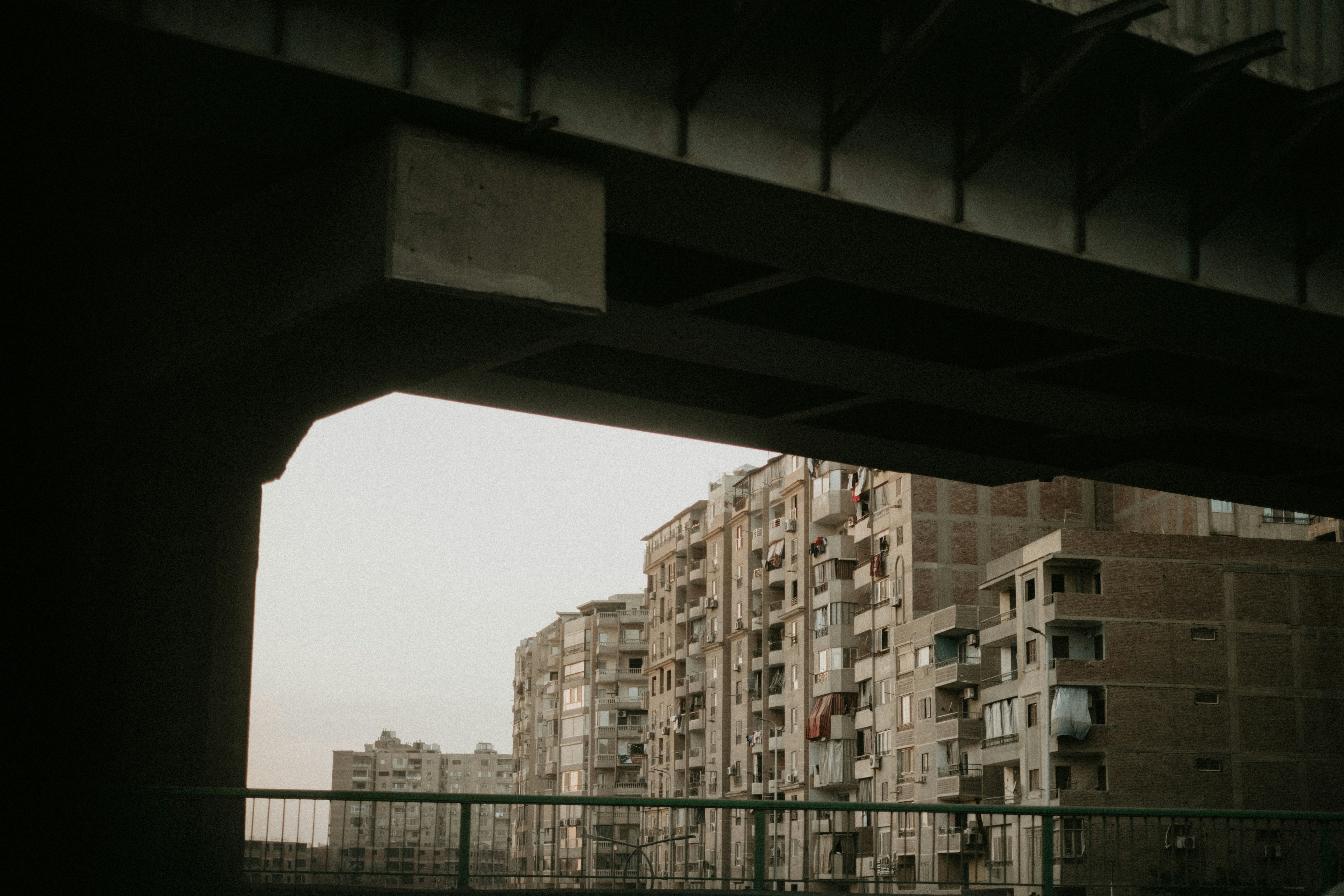 Concrete Canopy Overlook: Distant Housing Under an Urban Span