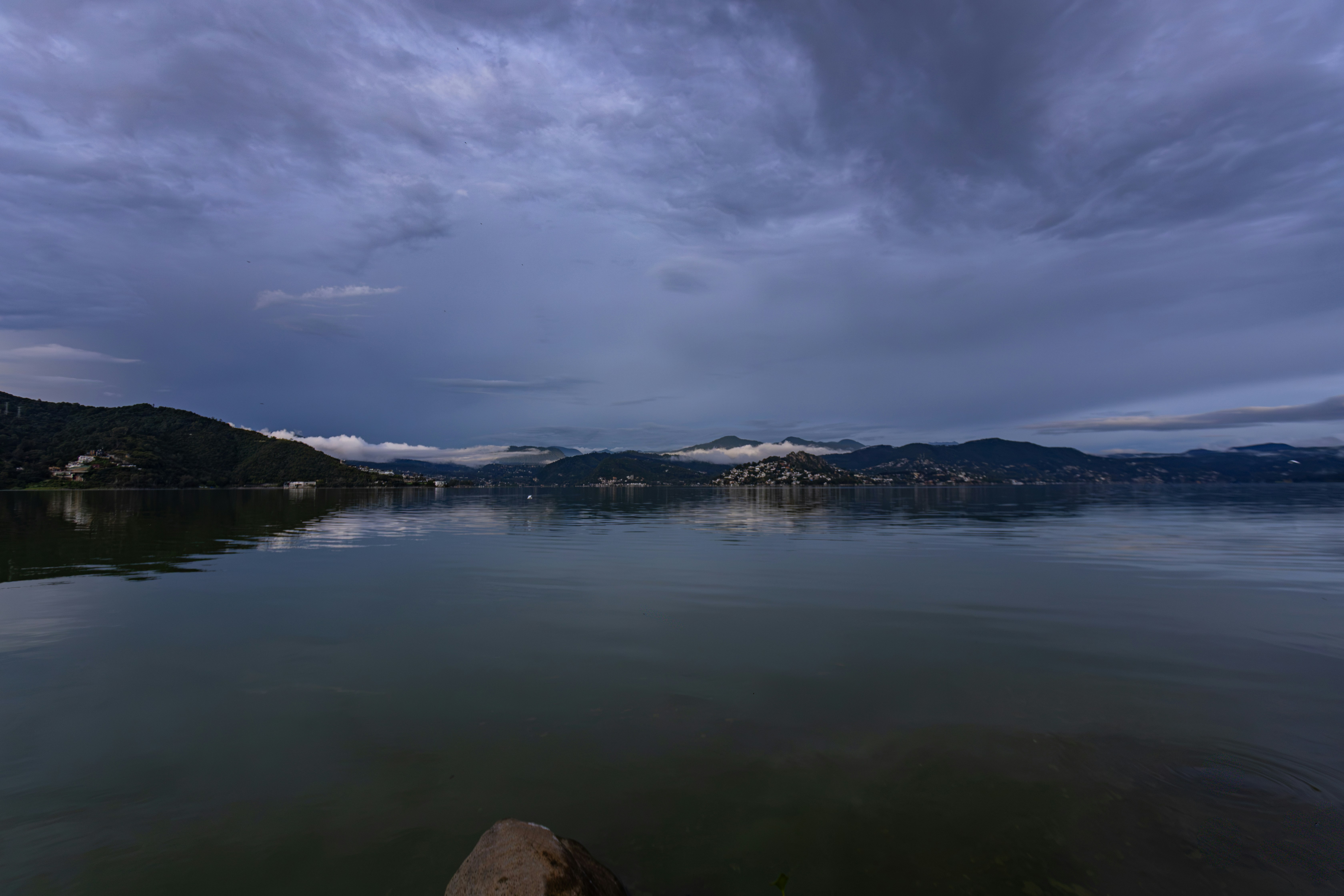 Still Waters Under a Vast Sky Over a Mountain Lake