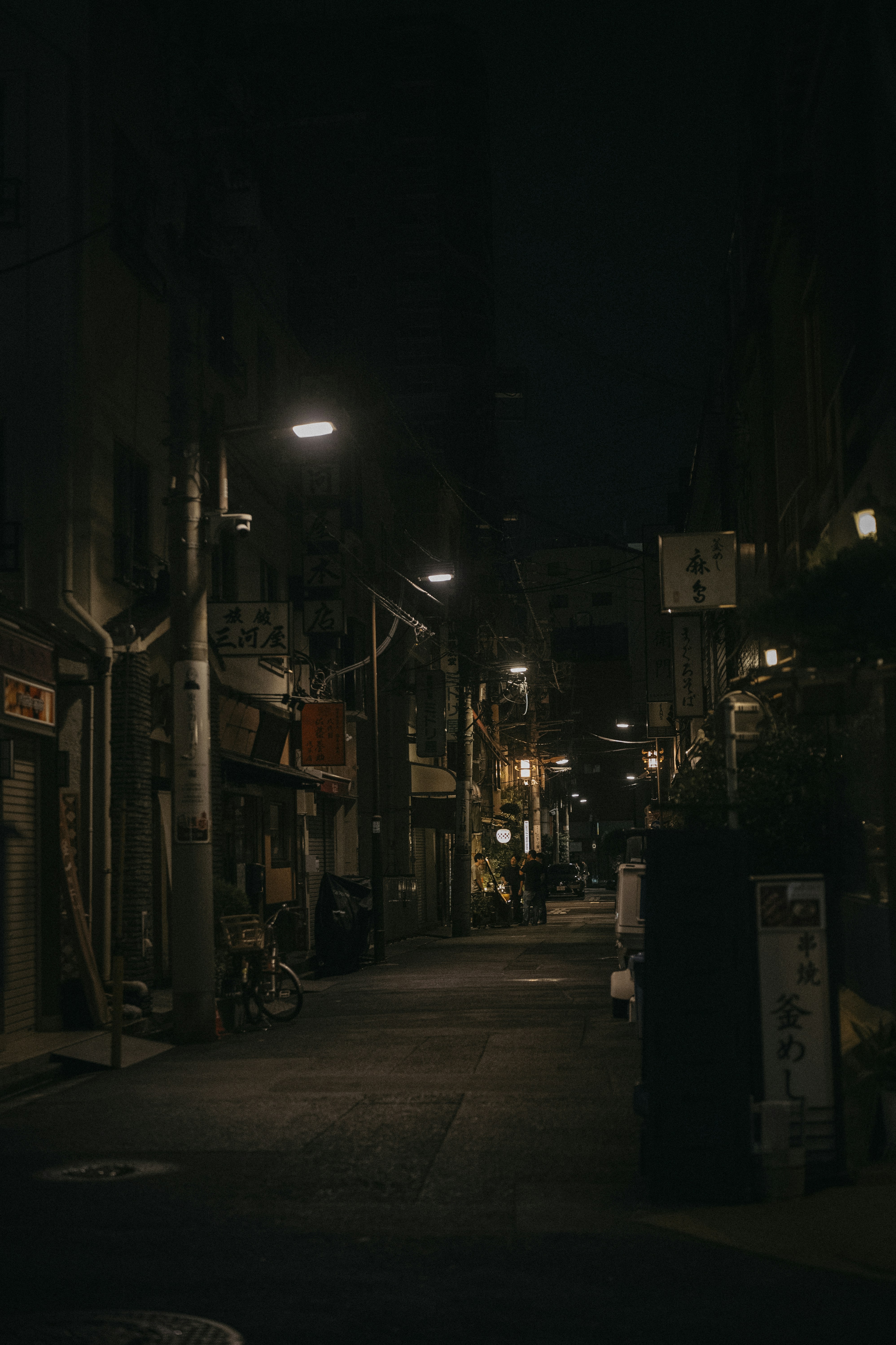 Night Alley in Quiet Tokyo: A Dimly Lit Street Surrounded by Shuttered Shops