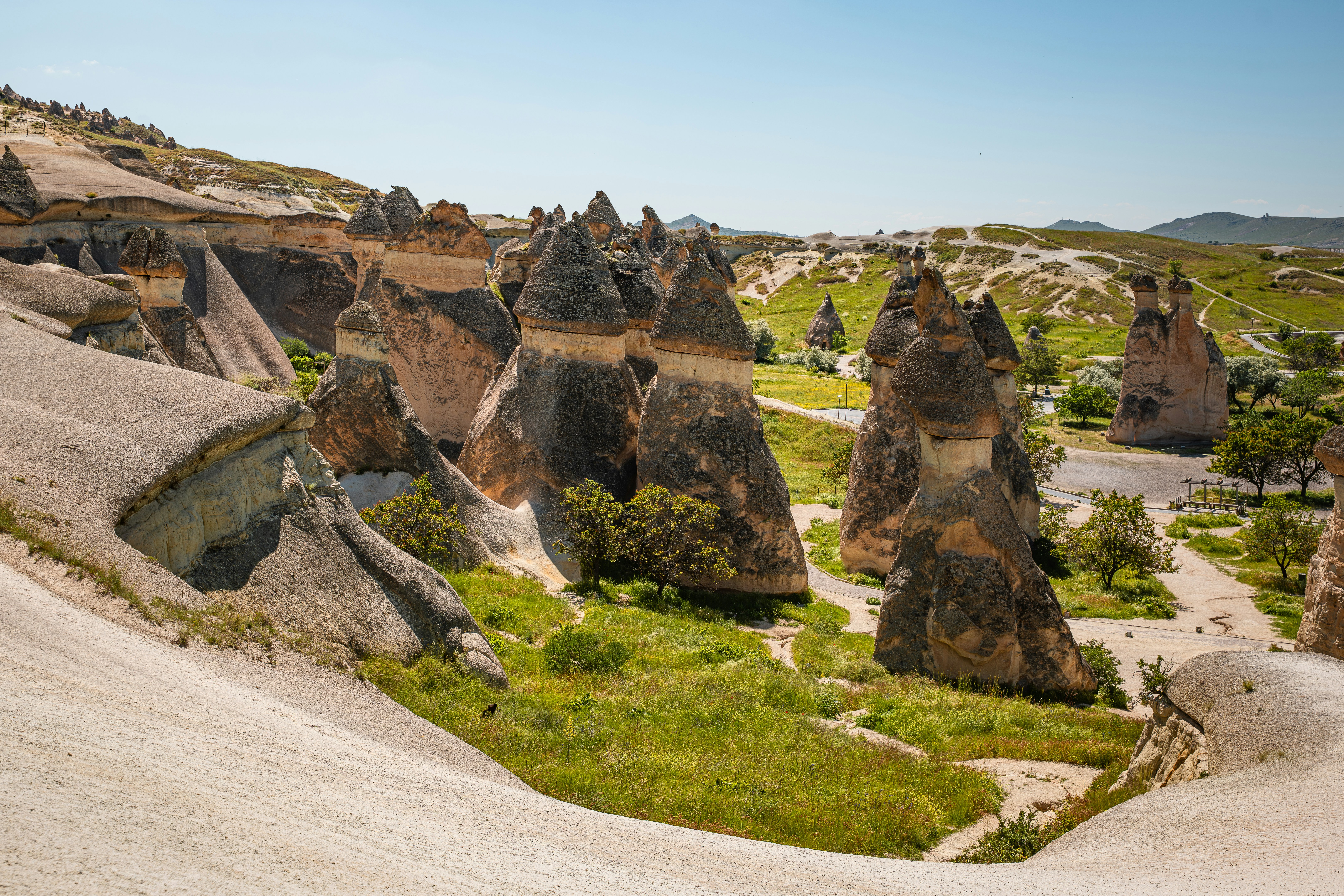 Stone Choir in the Dust: Eroded Spires Under a Wide Blue Sky