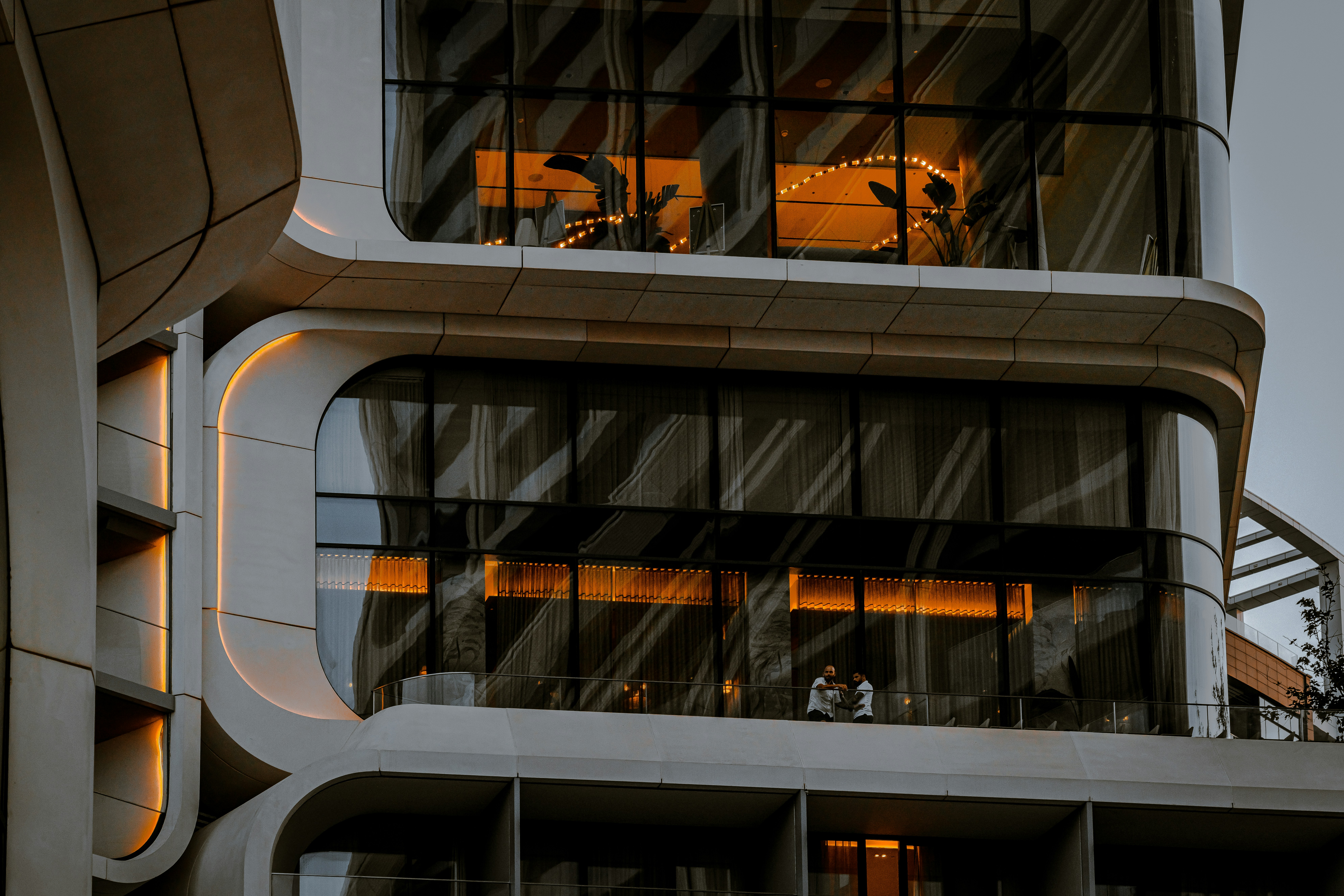 Curved Facade Echoes: Neon Edges on a Modern Curve