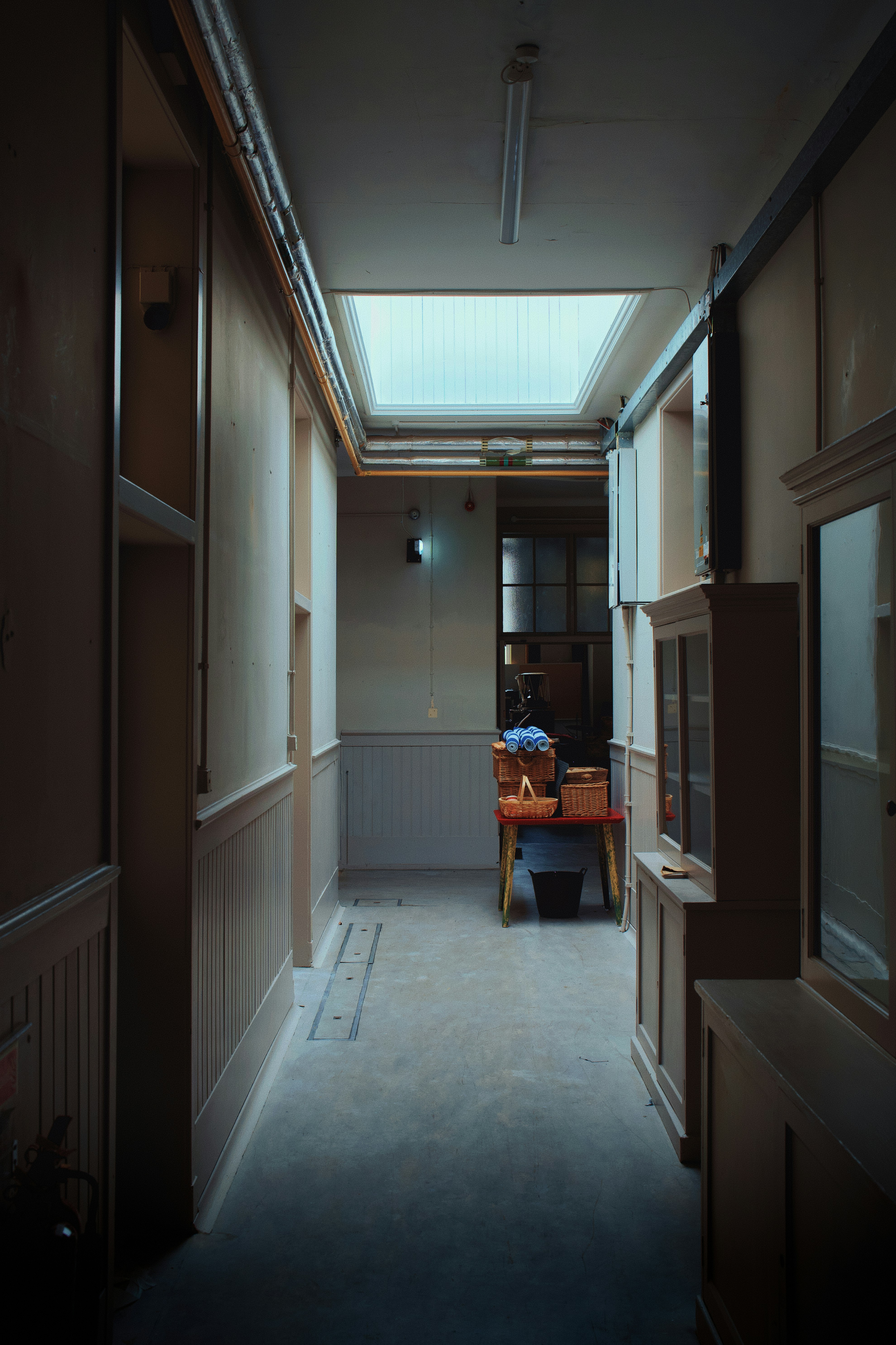 Inventory Hall: A Quiet Corridor Leading to a Sunlit Back Room