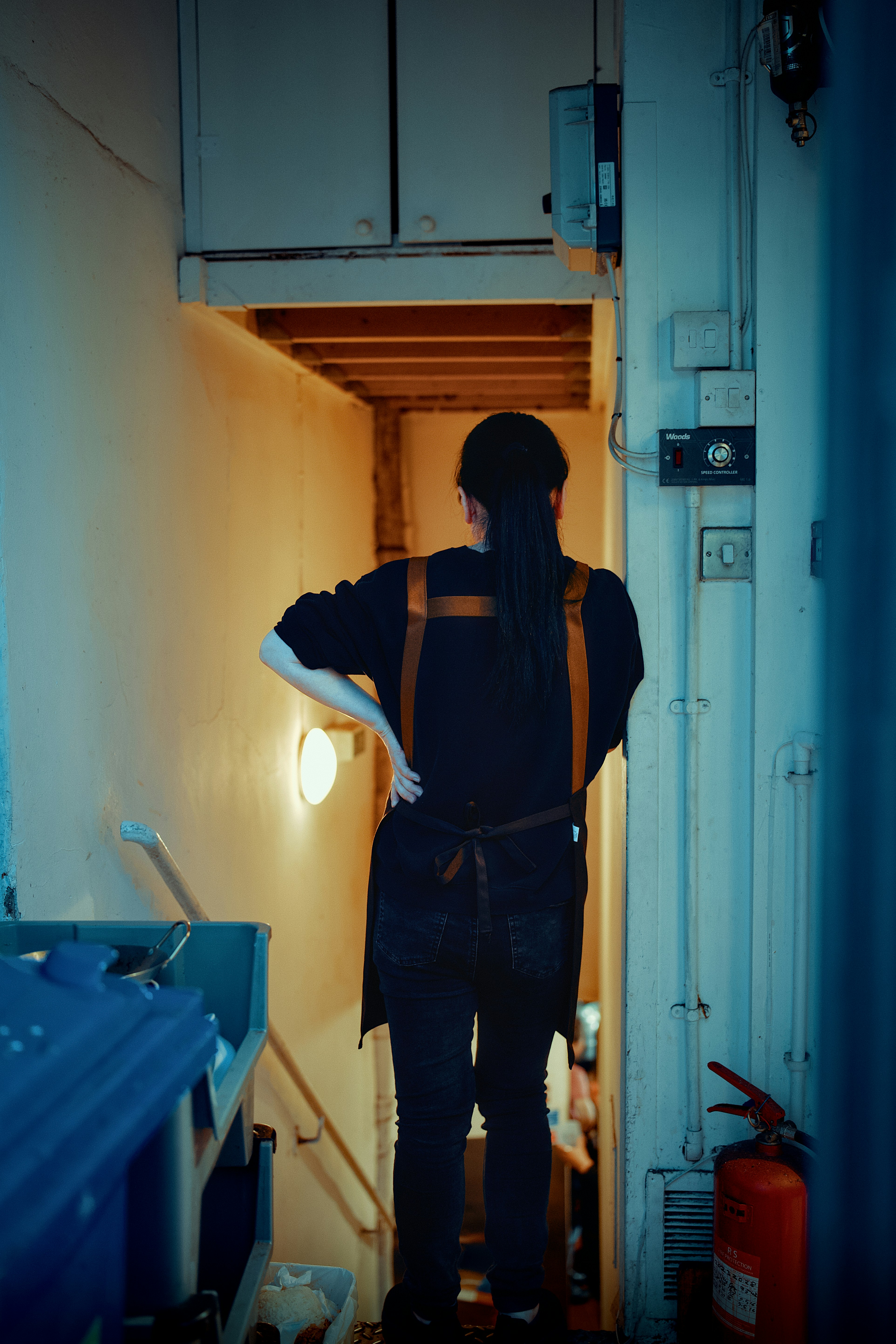 Backlit Operator in a Neon Corridor