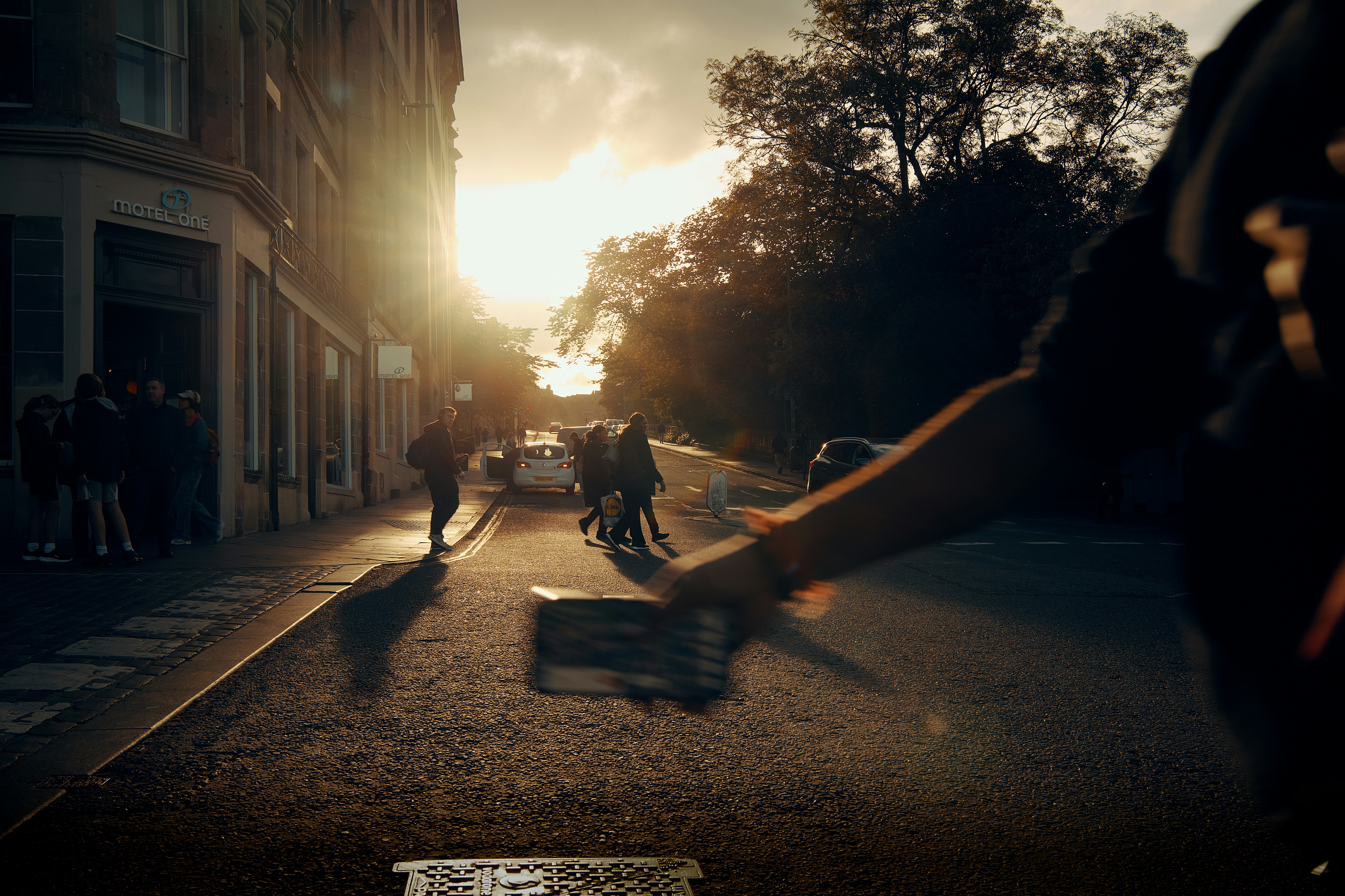 Sunlit Street Rush: A fleeting moment in motion blur