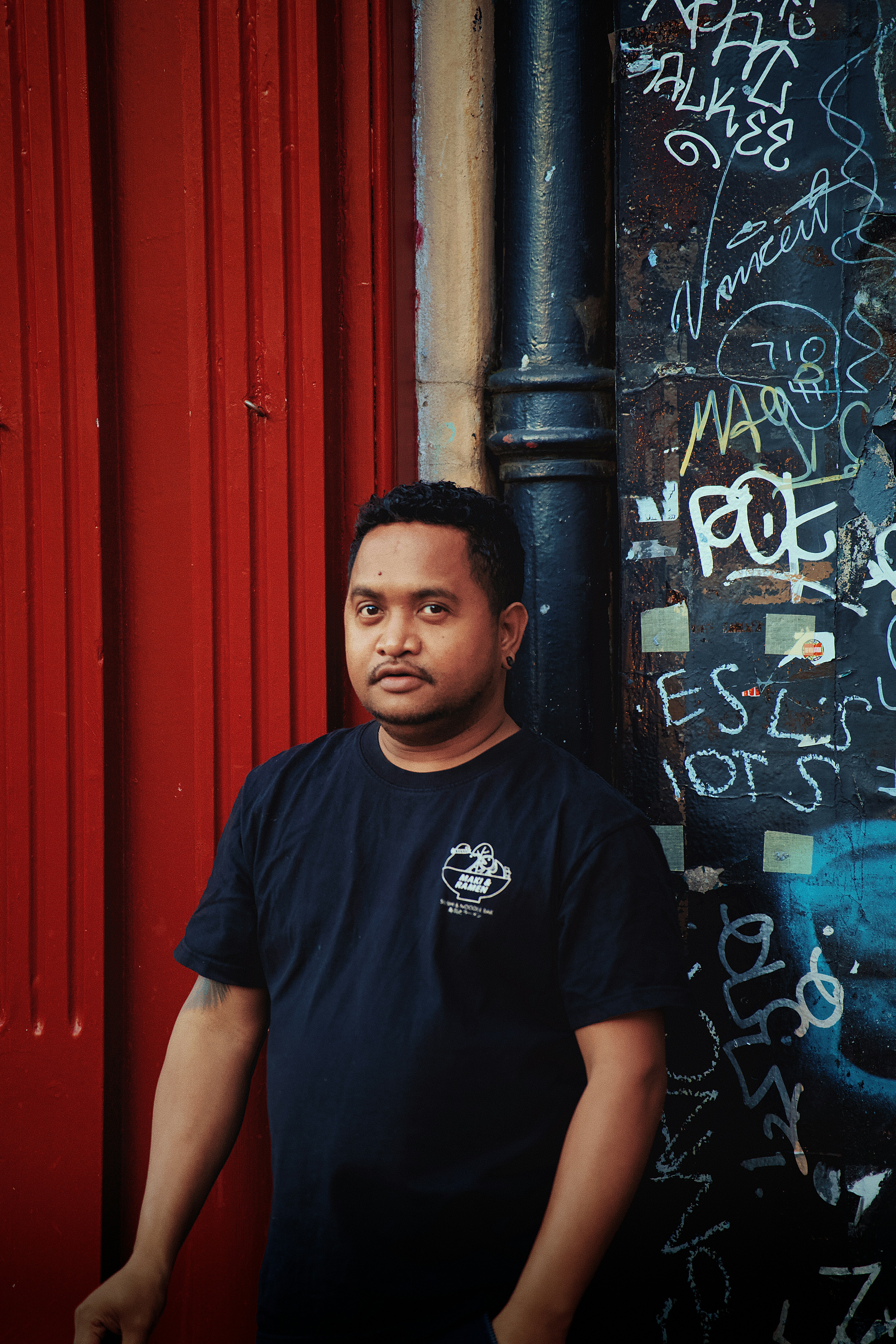 Urban Portrait: Quiet Confidence in a Graffiti Alley
