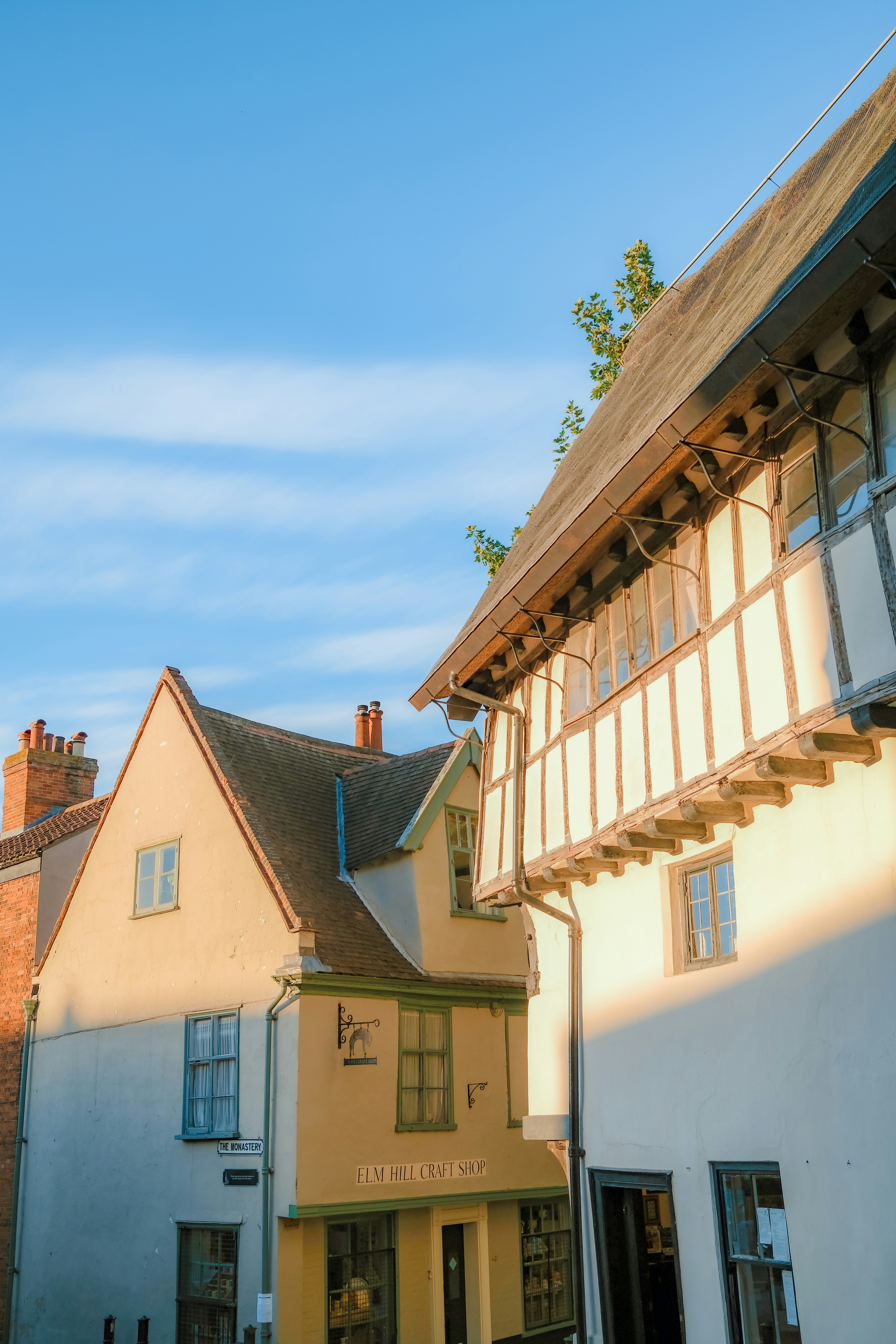 Sunlit Timbered Facades: A Quiet Street in Warm Evening Light