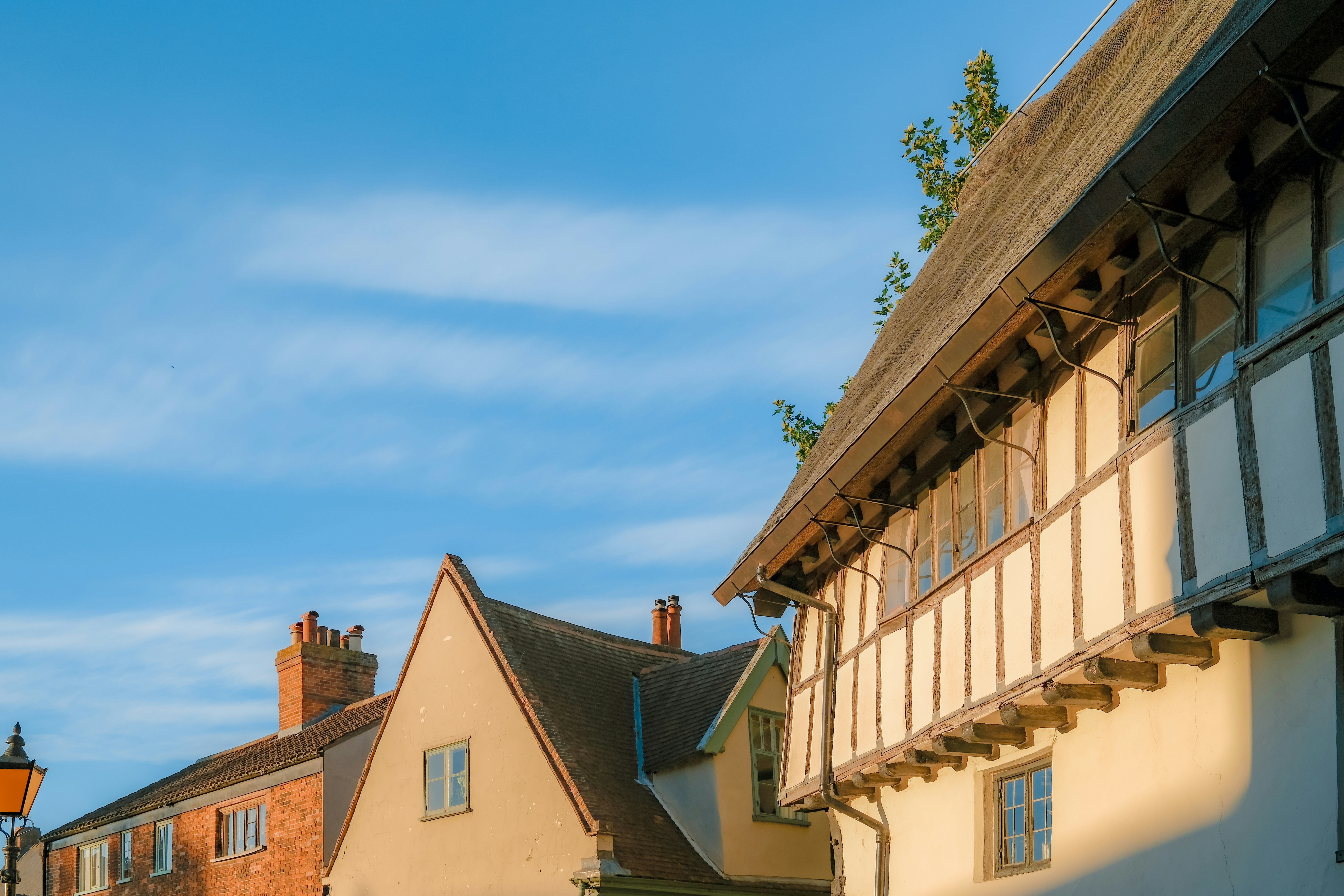 Sunlit Timber and Gable Lines: A Quiet Village Roofscape