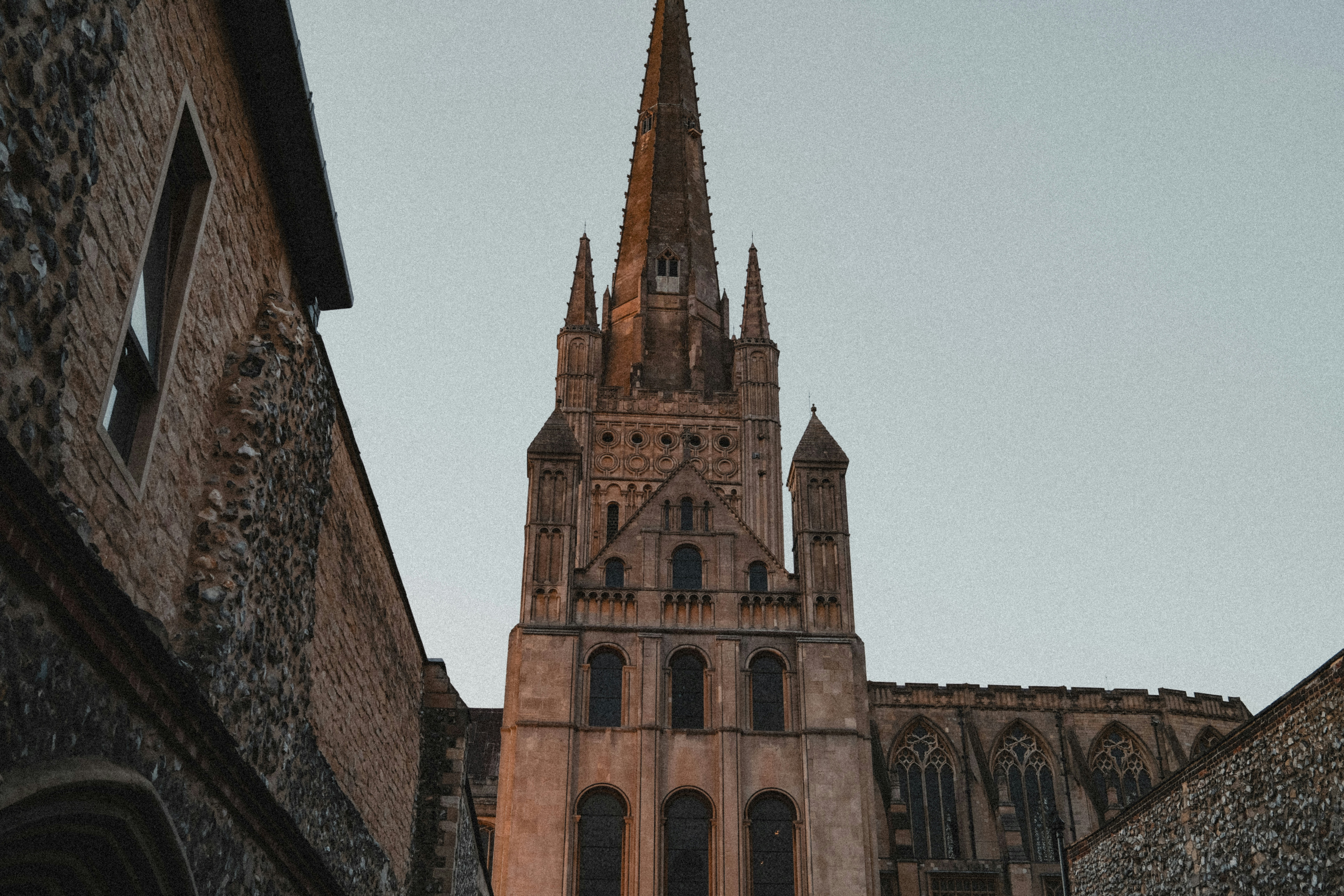 Gothic Spire Silhouette Rising Between Narrow Courtyards