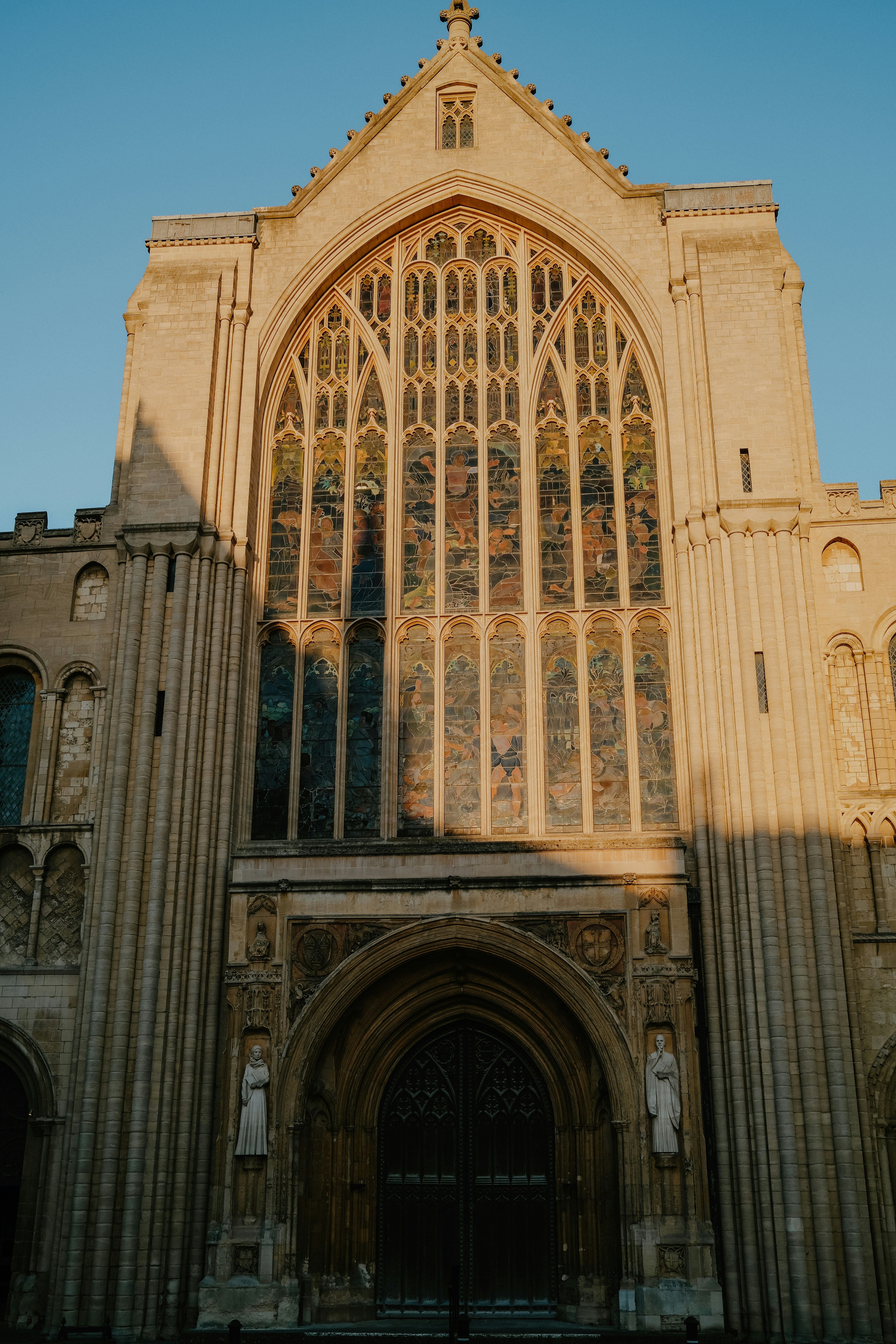 Gothic Facade in Evening Light: Stained Glass and Archway