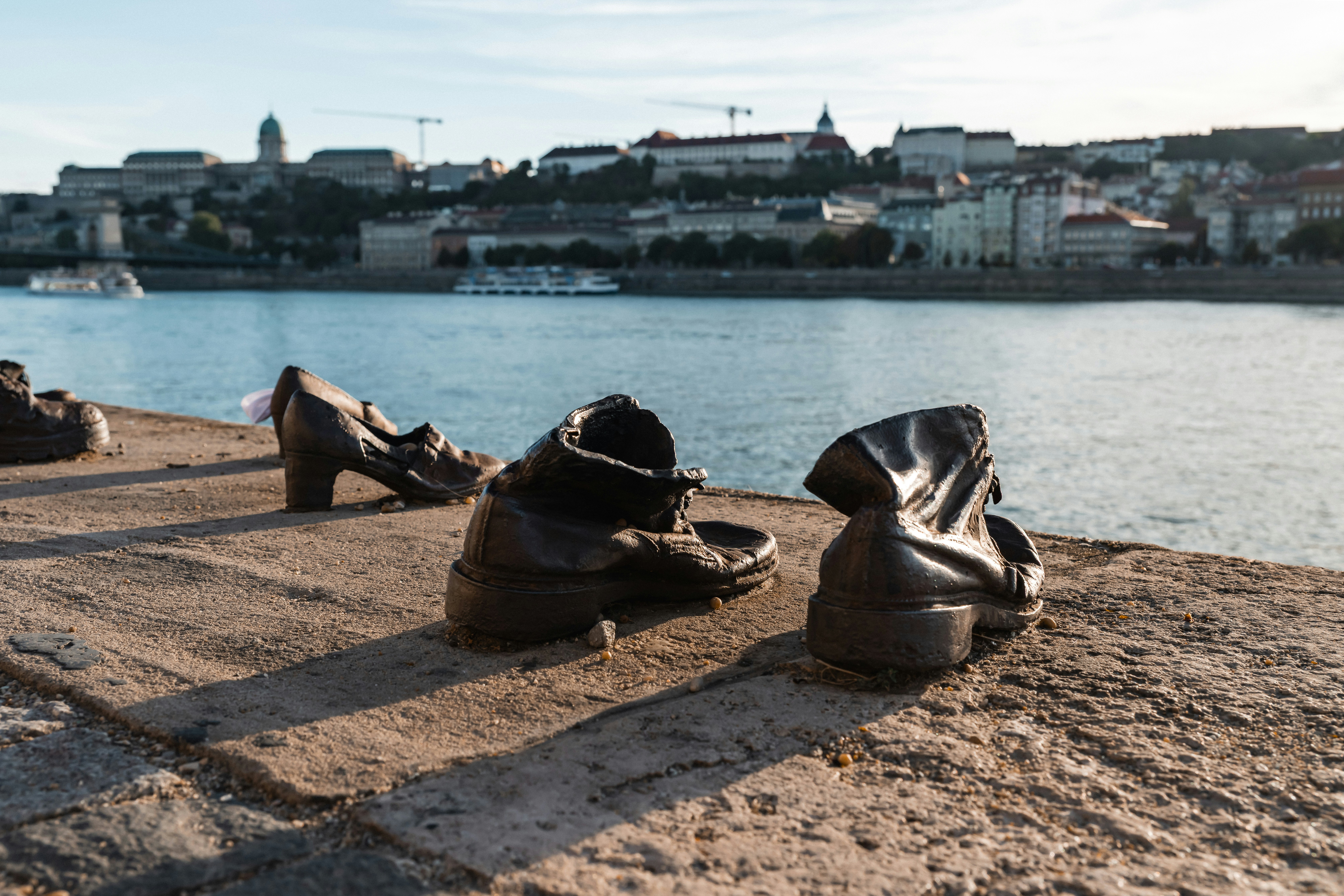 Abandoned Shoes by the River: Silent Echoes of a Waterfront City
