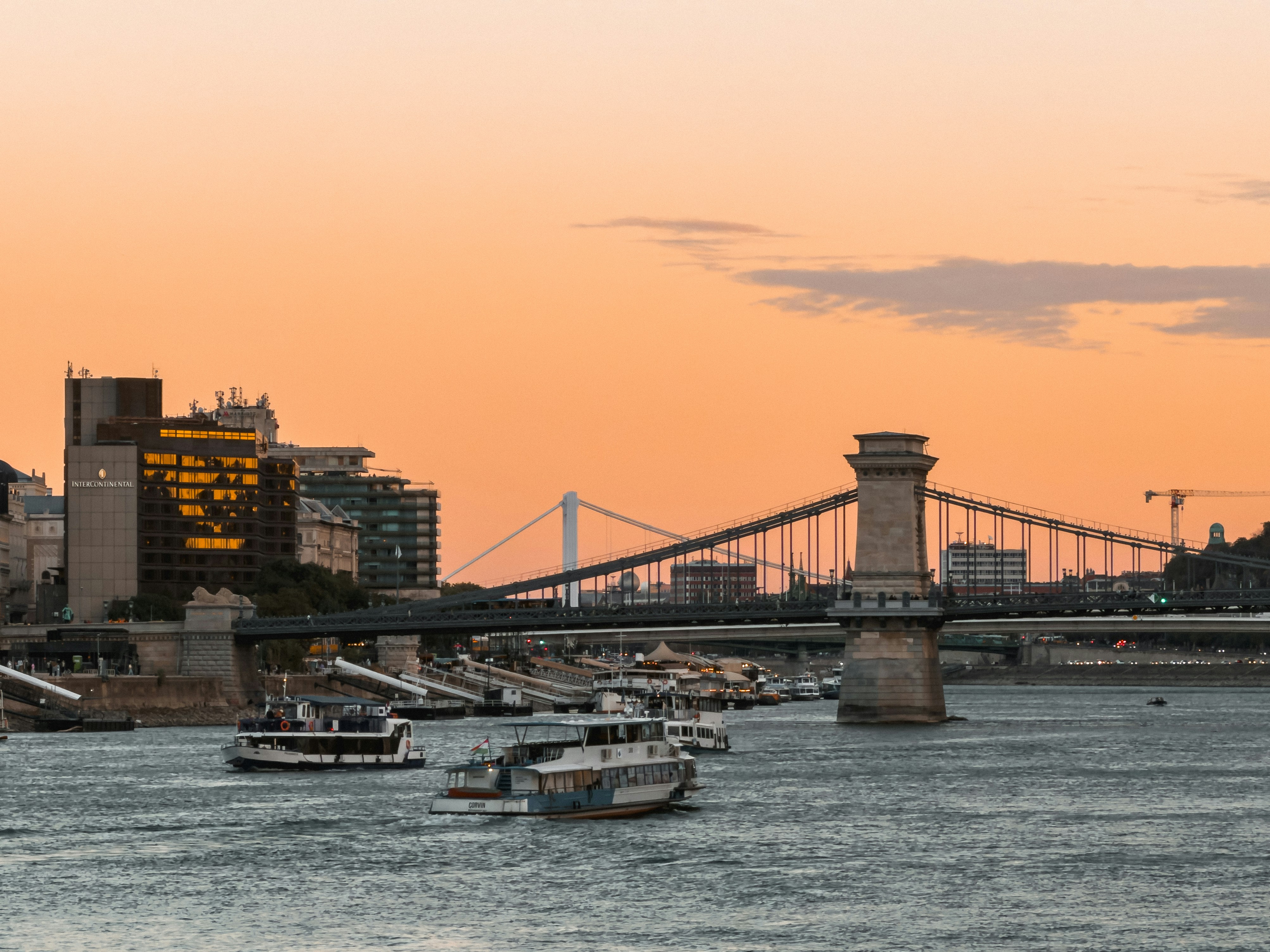 Sunset over the Thames: Bridge, riverboats, and skyline