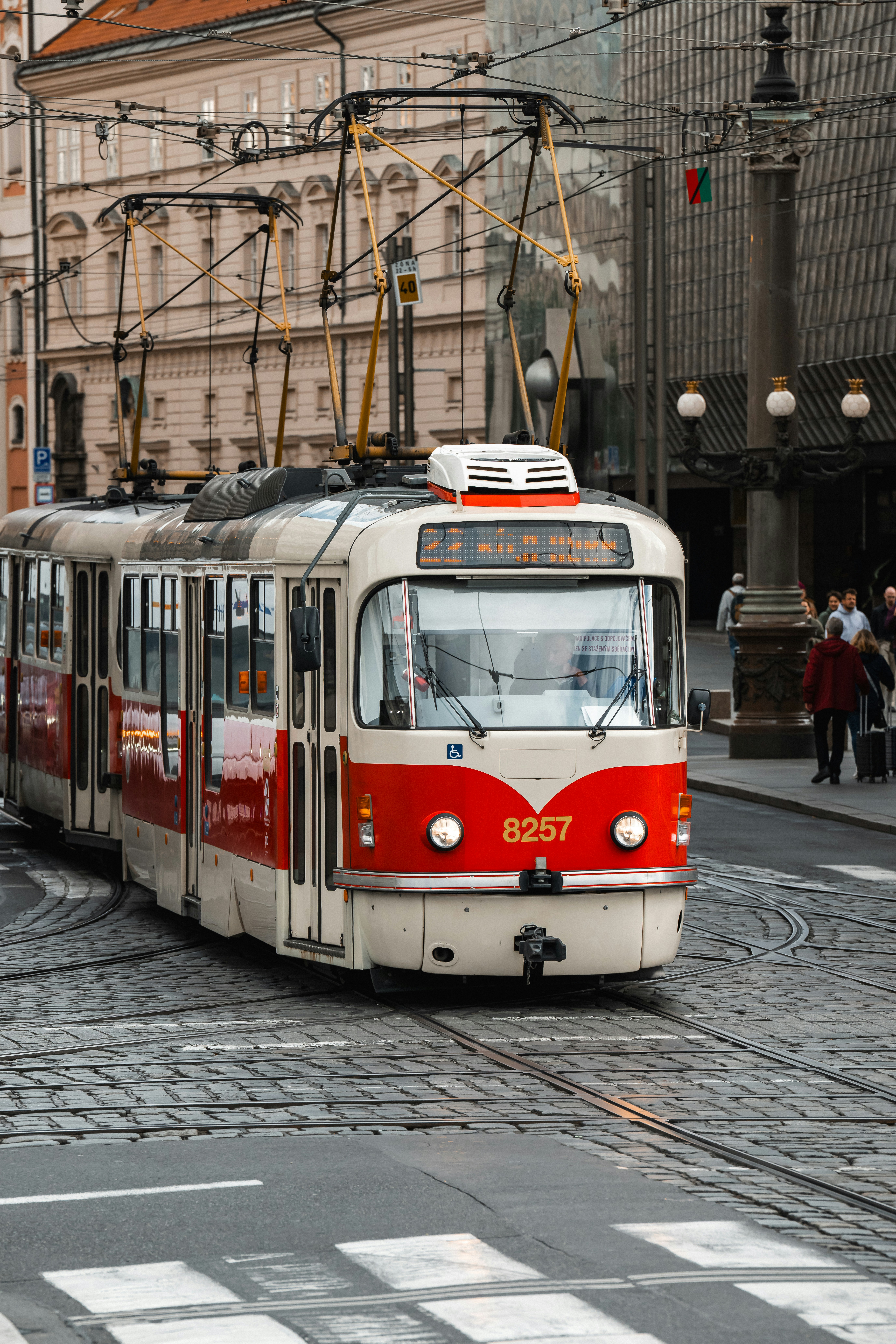  tram in motion: red and white electric train cutting through a European street