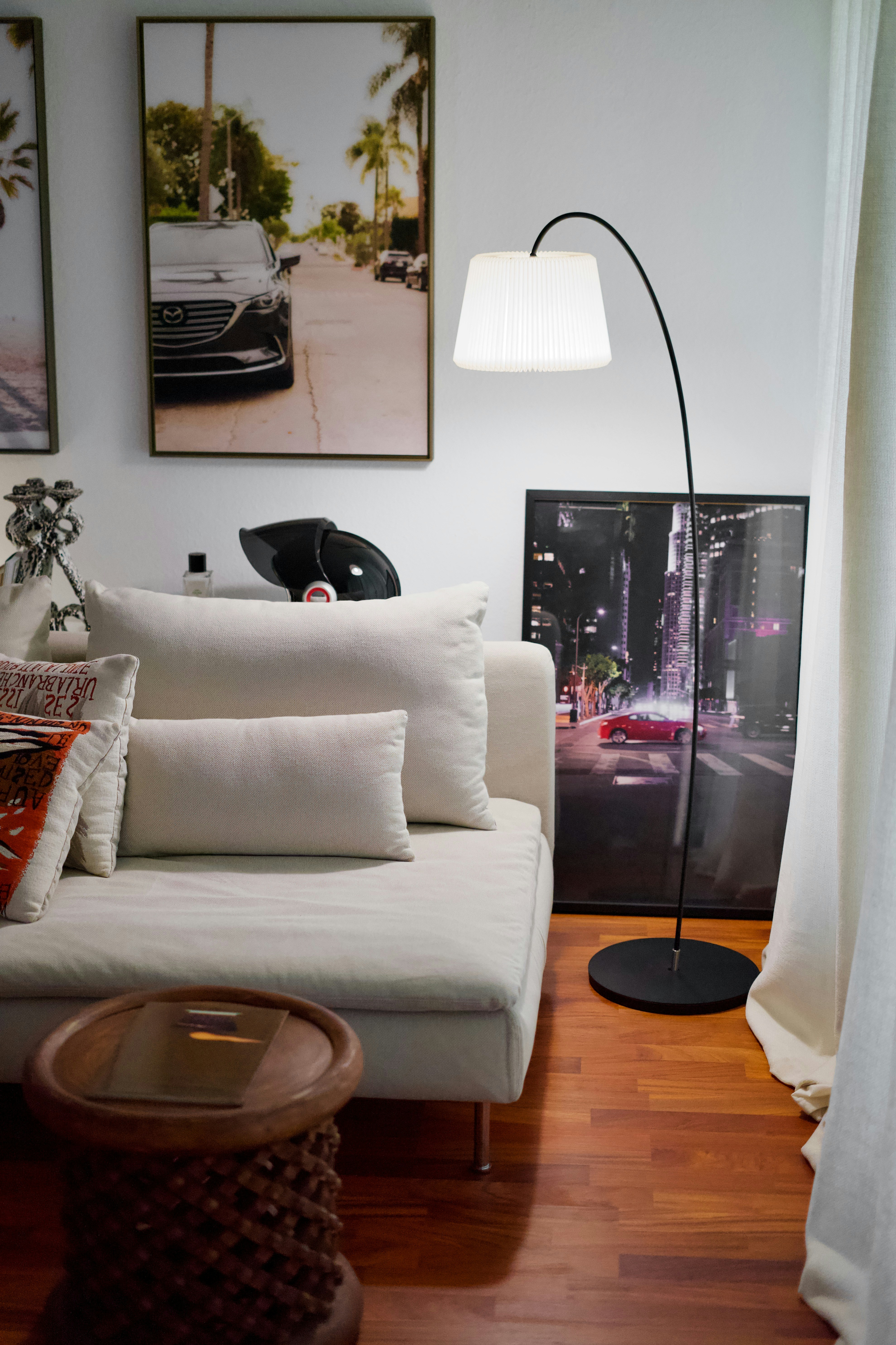 Cozy Corner Portrait: A luminous sofa beneath framed city-night scenes