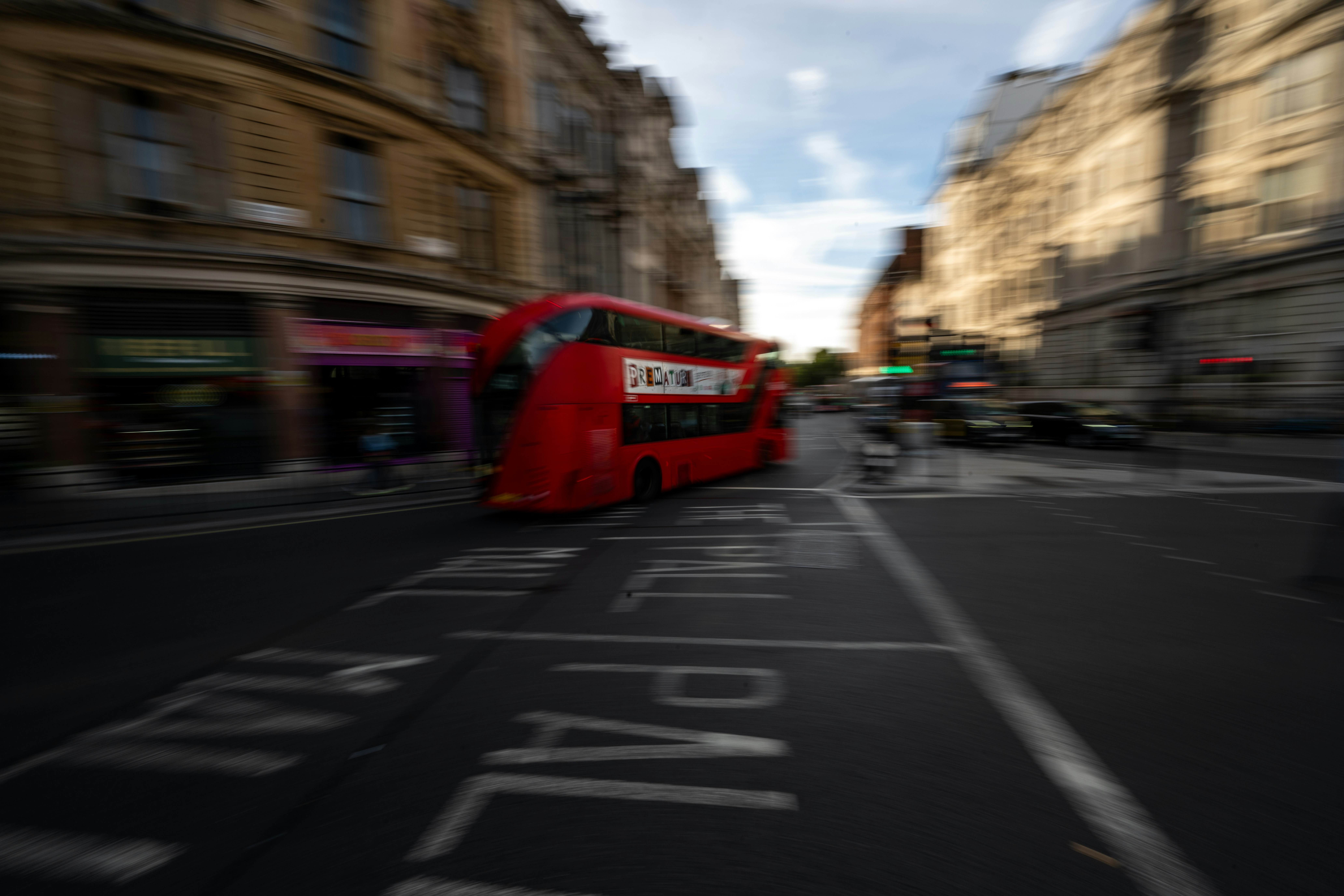 Motion in the City: Blurred Red Bus Traversing a London Street