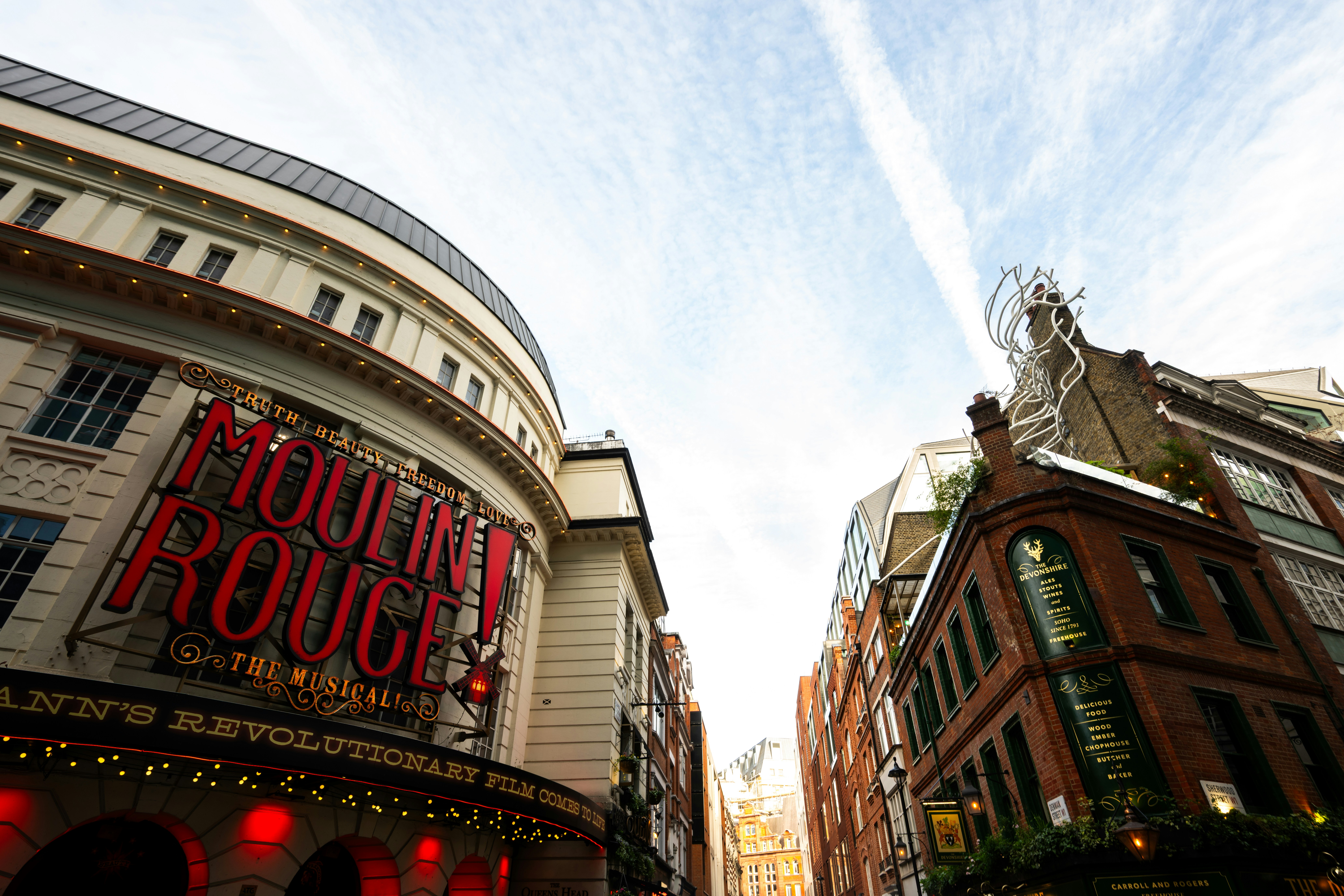 The Red Neon Gateway: Moulin Rouge on A Daybreak Boulevard