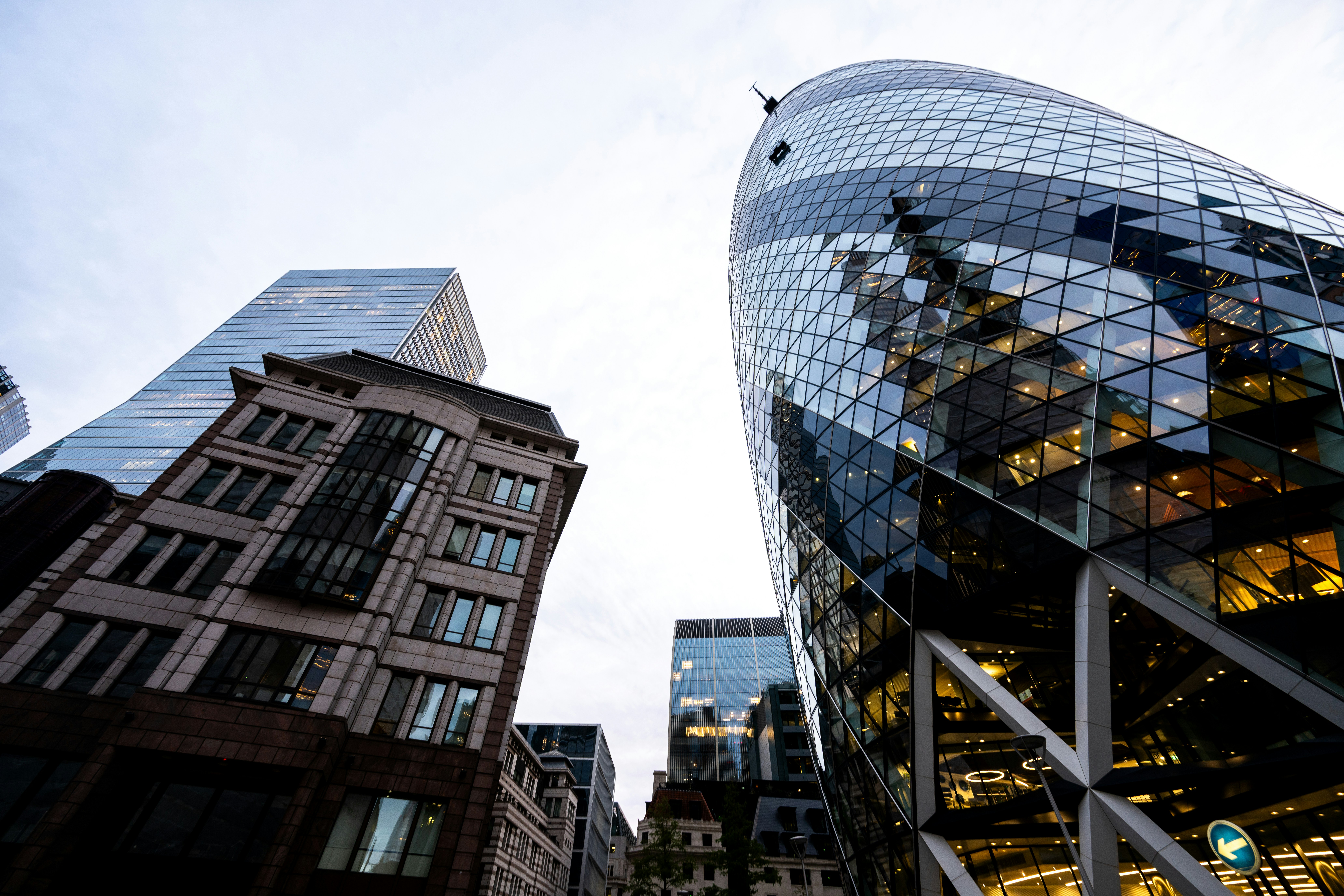 Cityscape Tilt: Glass and Brick Converge Under a Pale Sky
