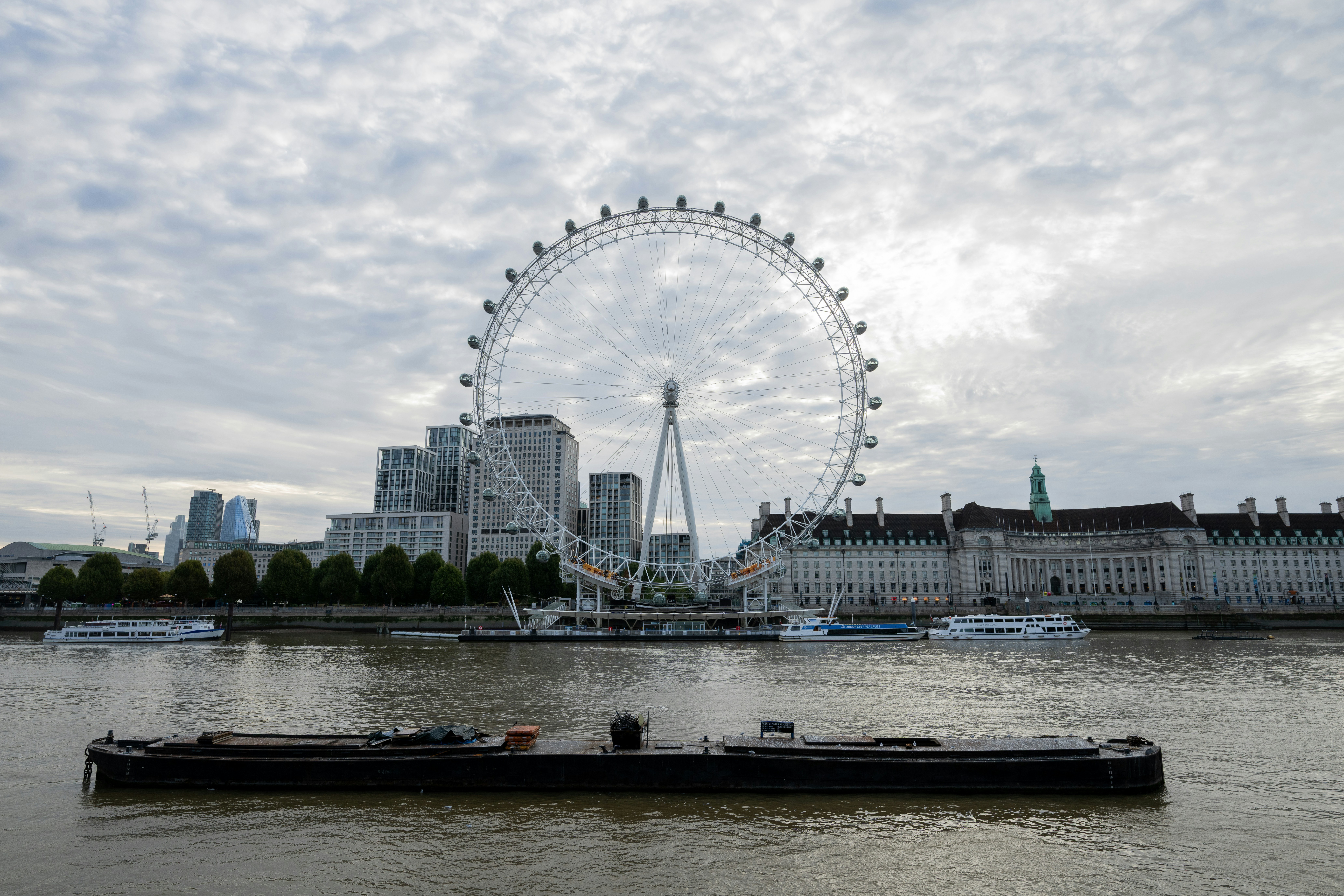 London Eye Over the Thames: Barge, Skyline, and Ferry