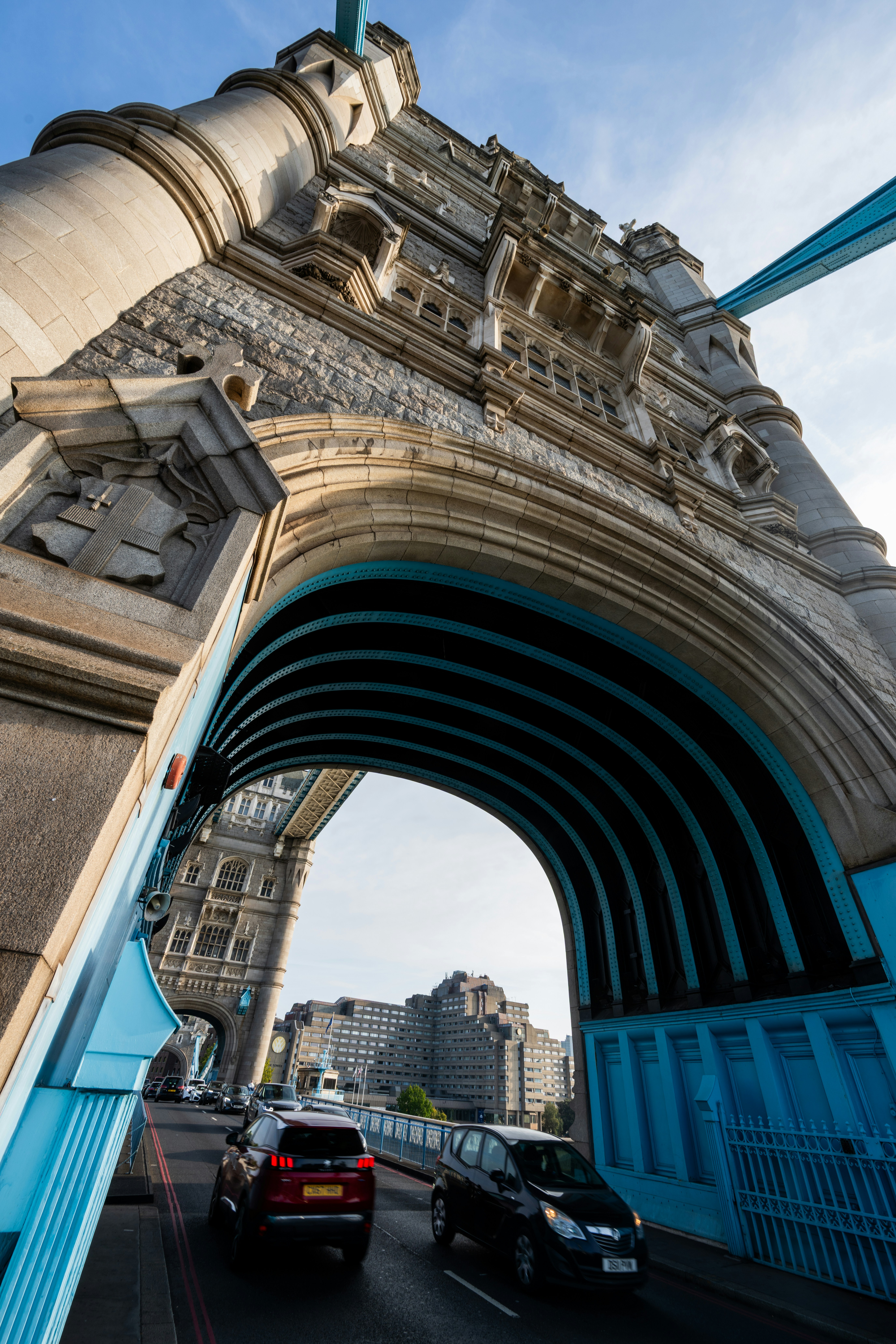 Blue Archways Under the Towering Bridge: A City Drive Through Tower Bridge