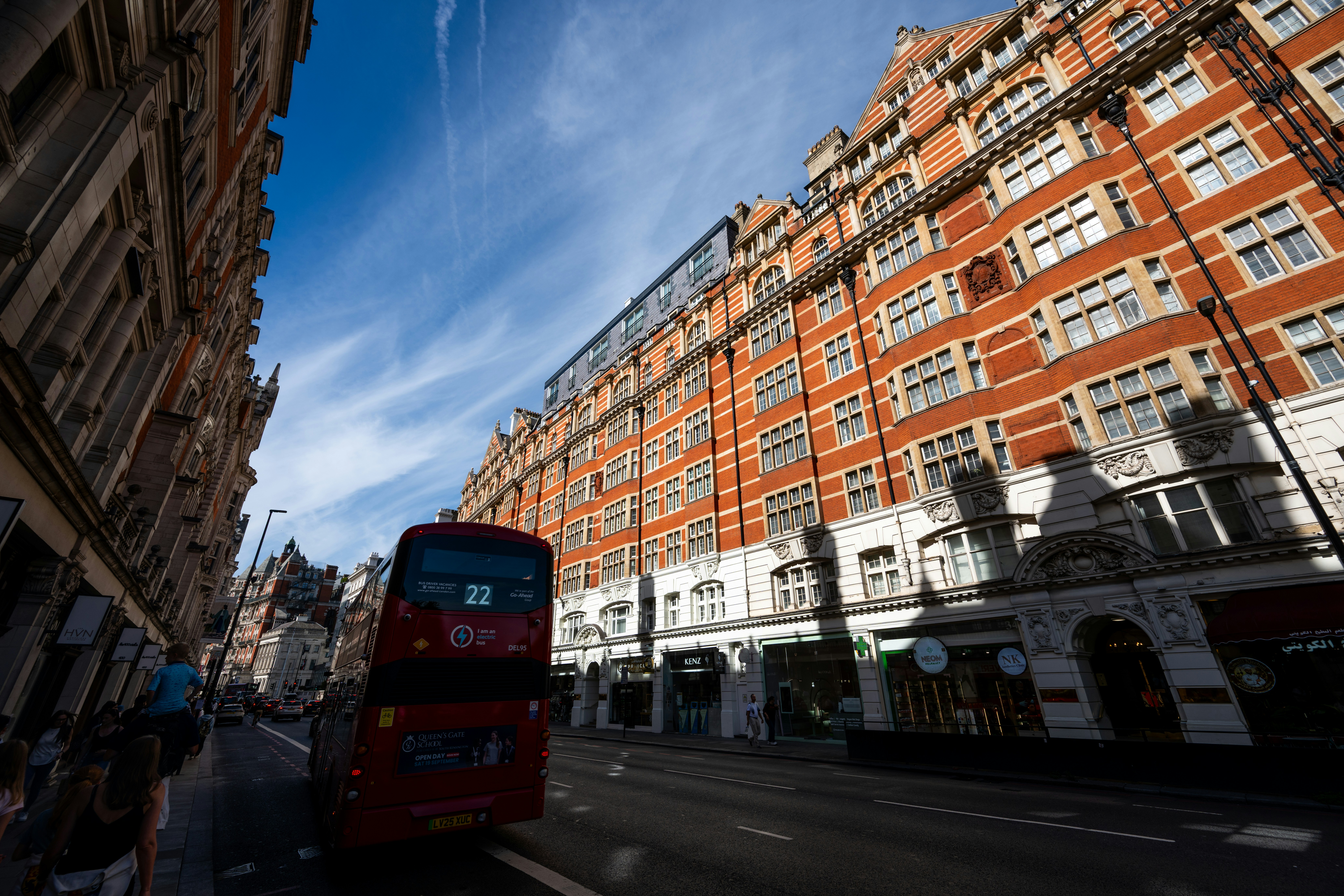 London Streetside: Red Double-Decker in a Sunlit Urban Canyon