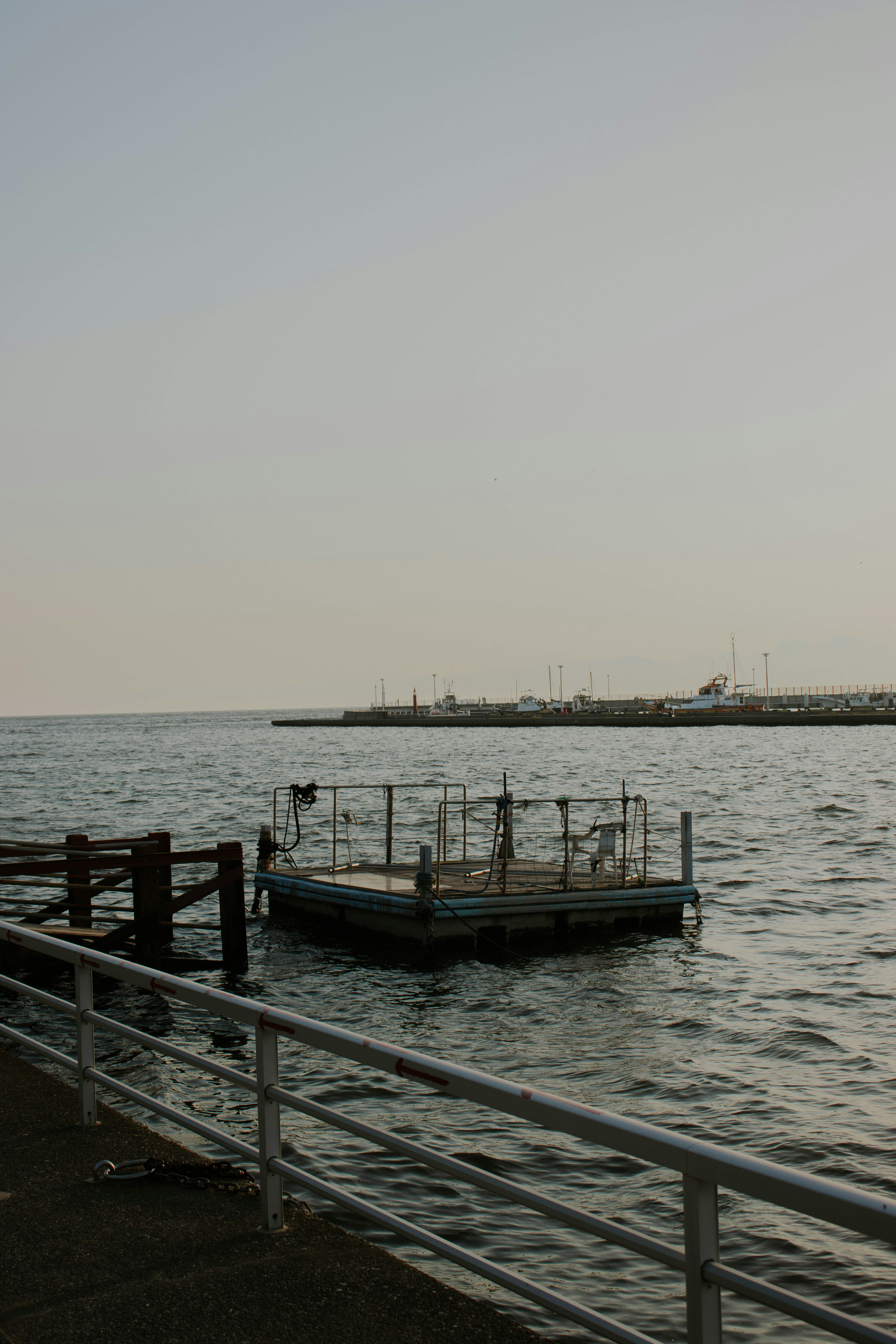 Quiet Marina at Dusk: A Pier's Edge with Floating Platform