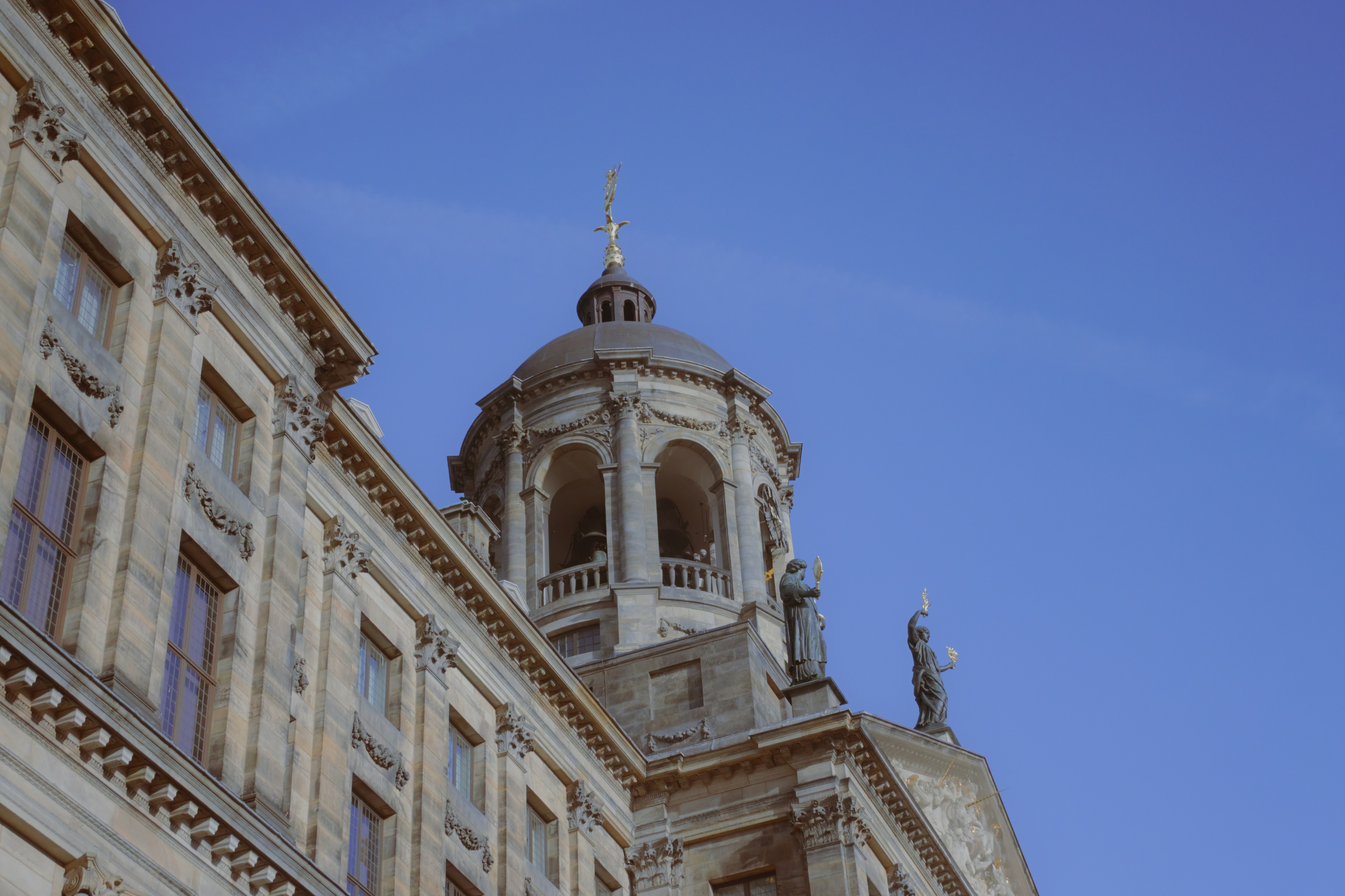 Stone Clocktower Silhouettes Against a Clear Blue Sky