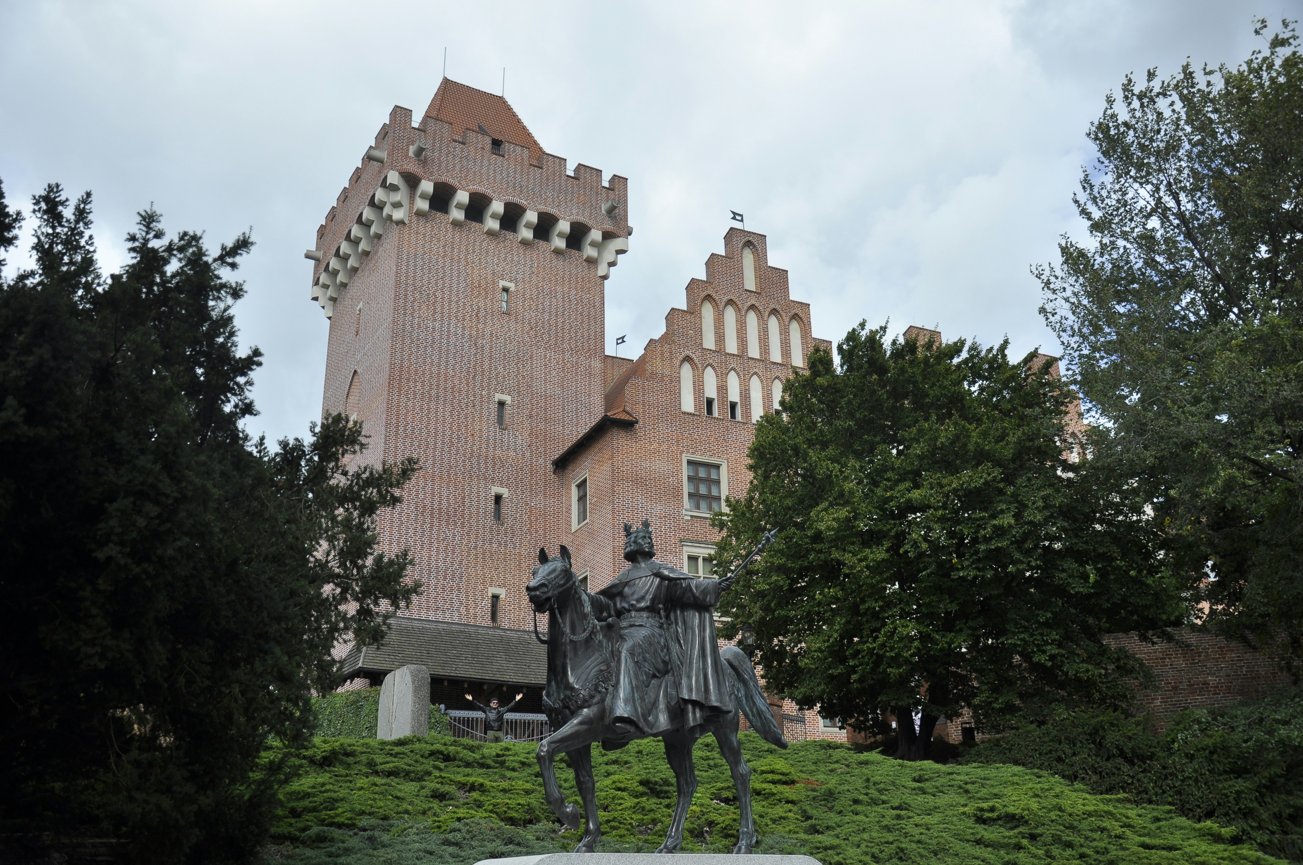 Equestrian Gate: A Medieval Fortress Framed by Tower and Trees