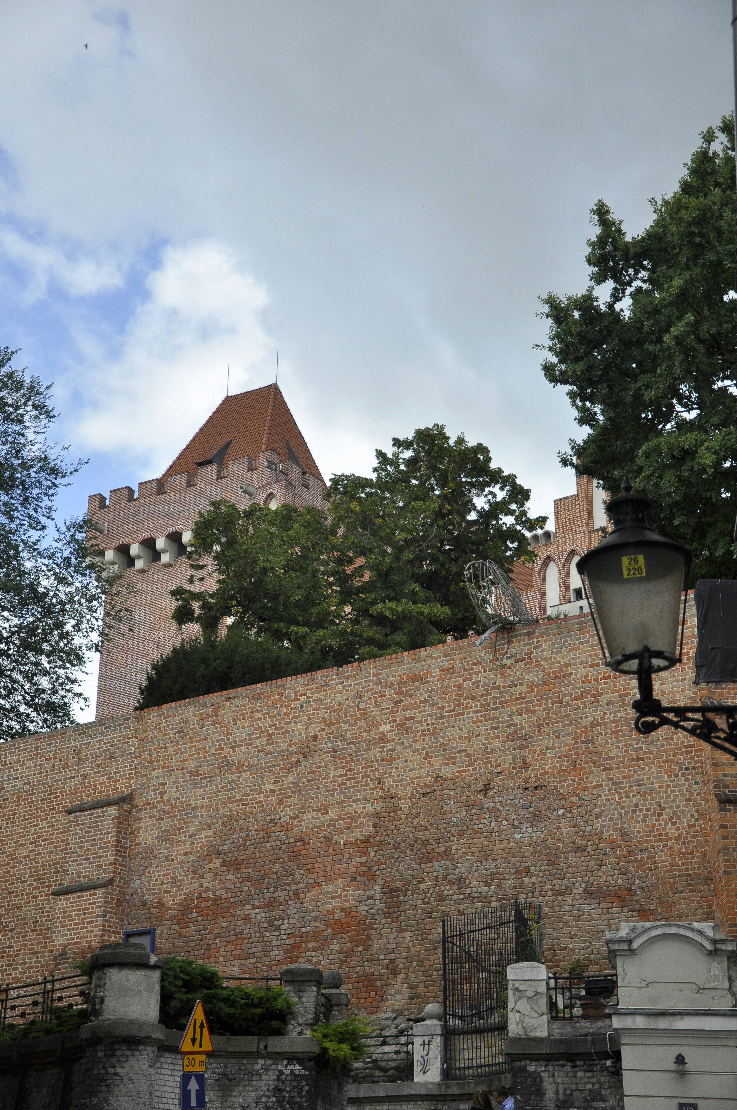 Castle Turret over a Brick Wall: Urban Heritage Under a Sky
