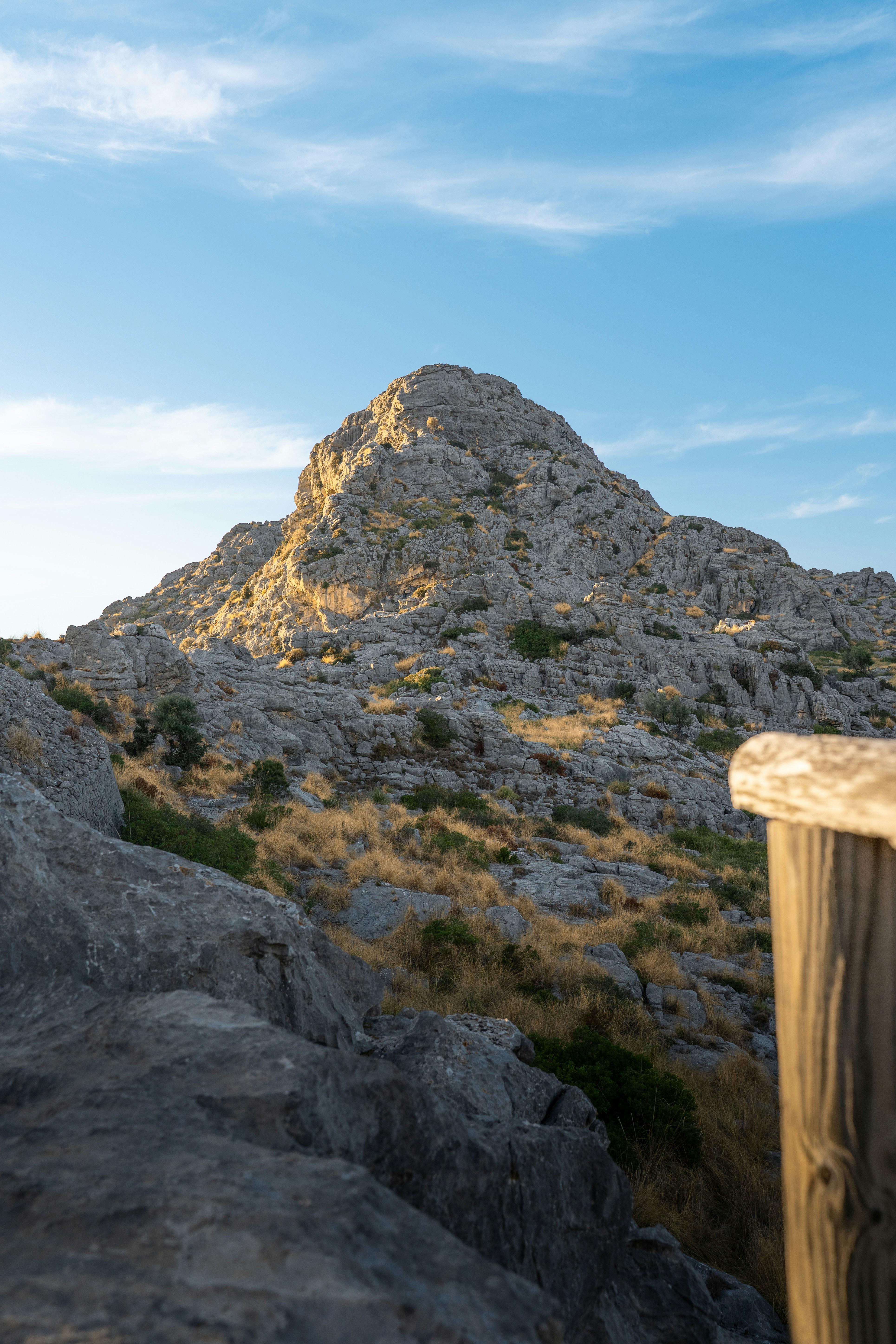 Sunlit Peak: A Jagged Prominence Amid Rocky Terrain