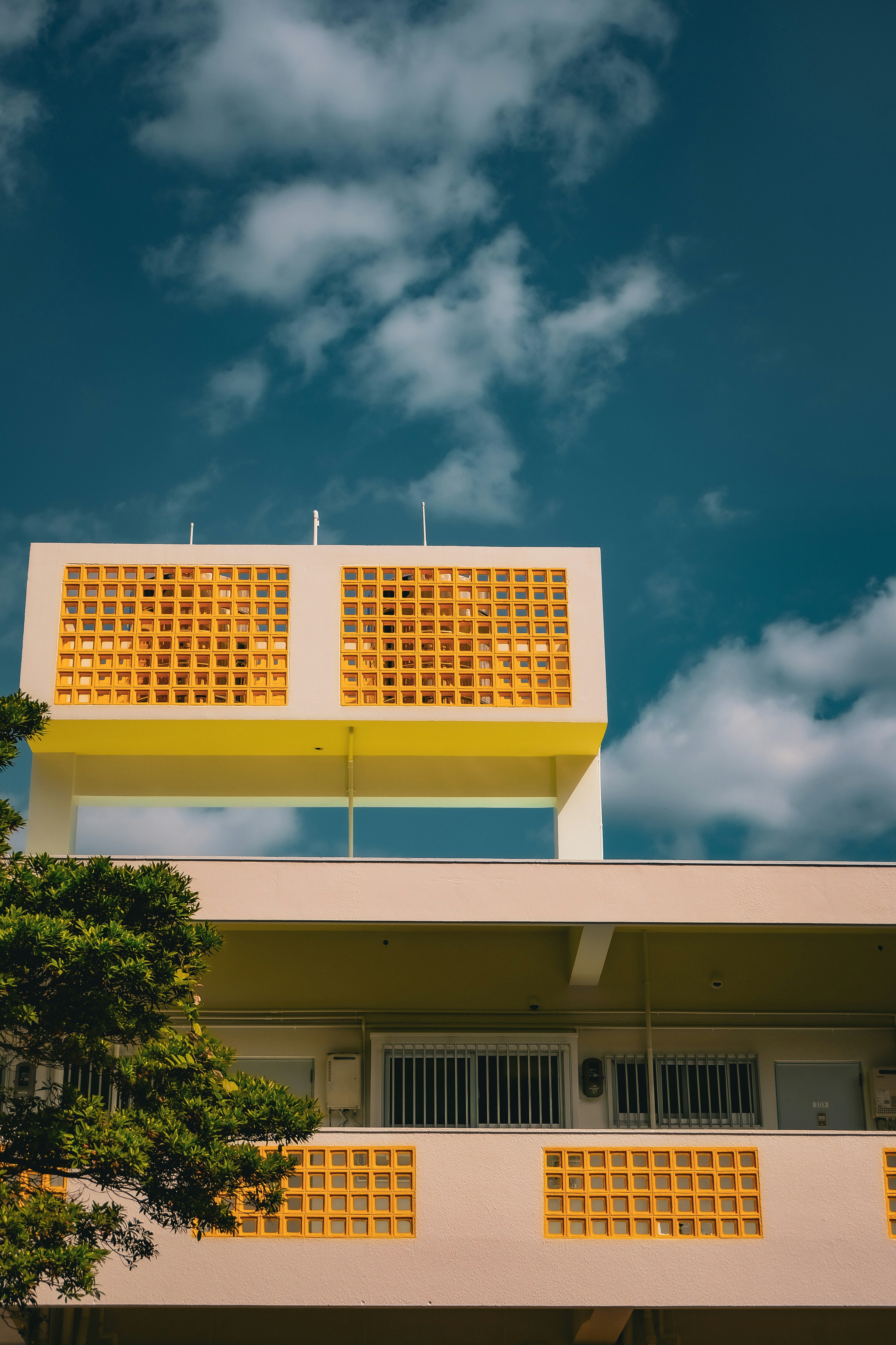 Sunny Modern Terrace: A Building's Grid of Amber Hues Against a Velvet Sky