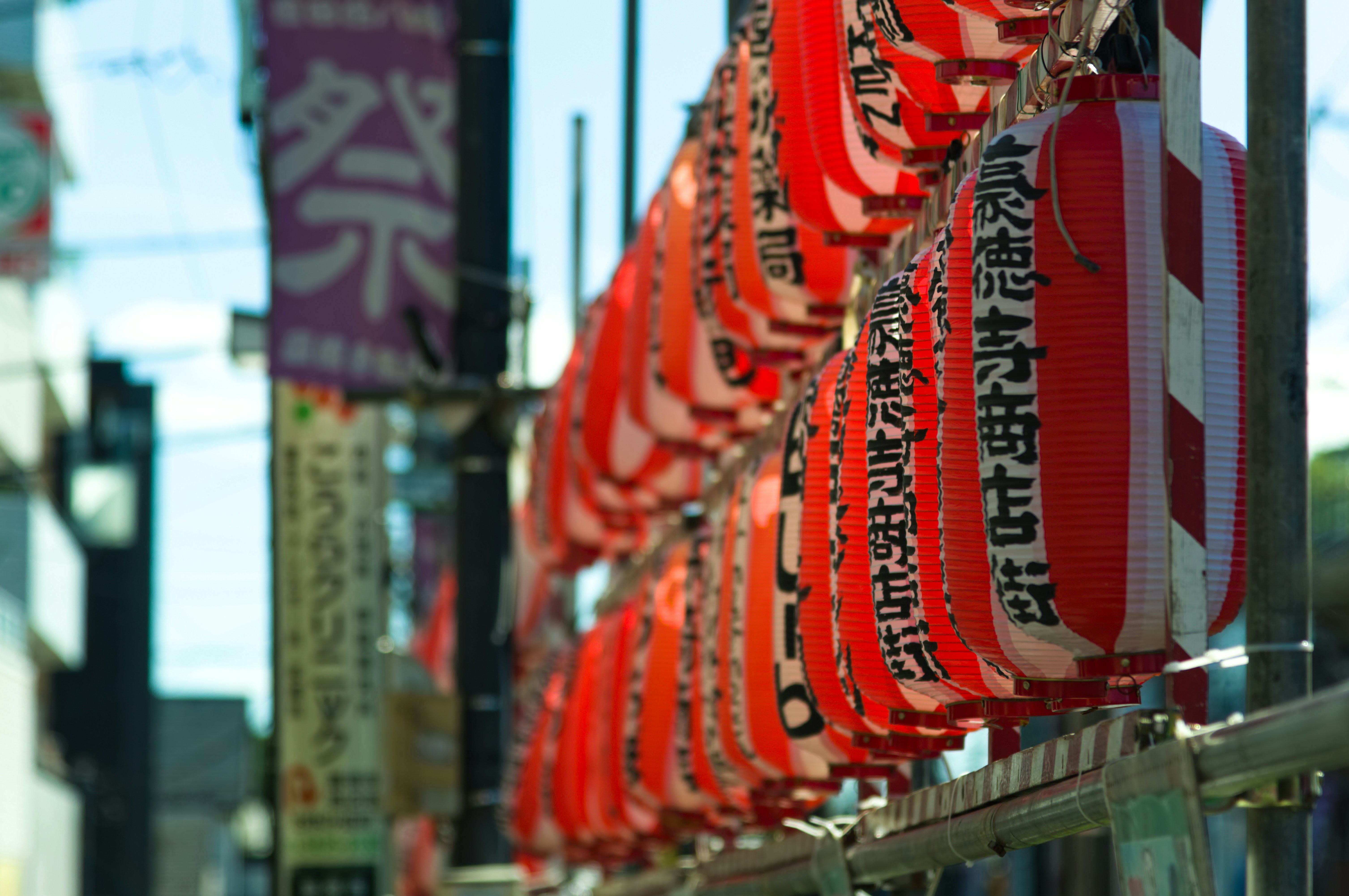 Red Lantern Lane: A string of glowing paper lamps in a busy Japanese street