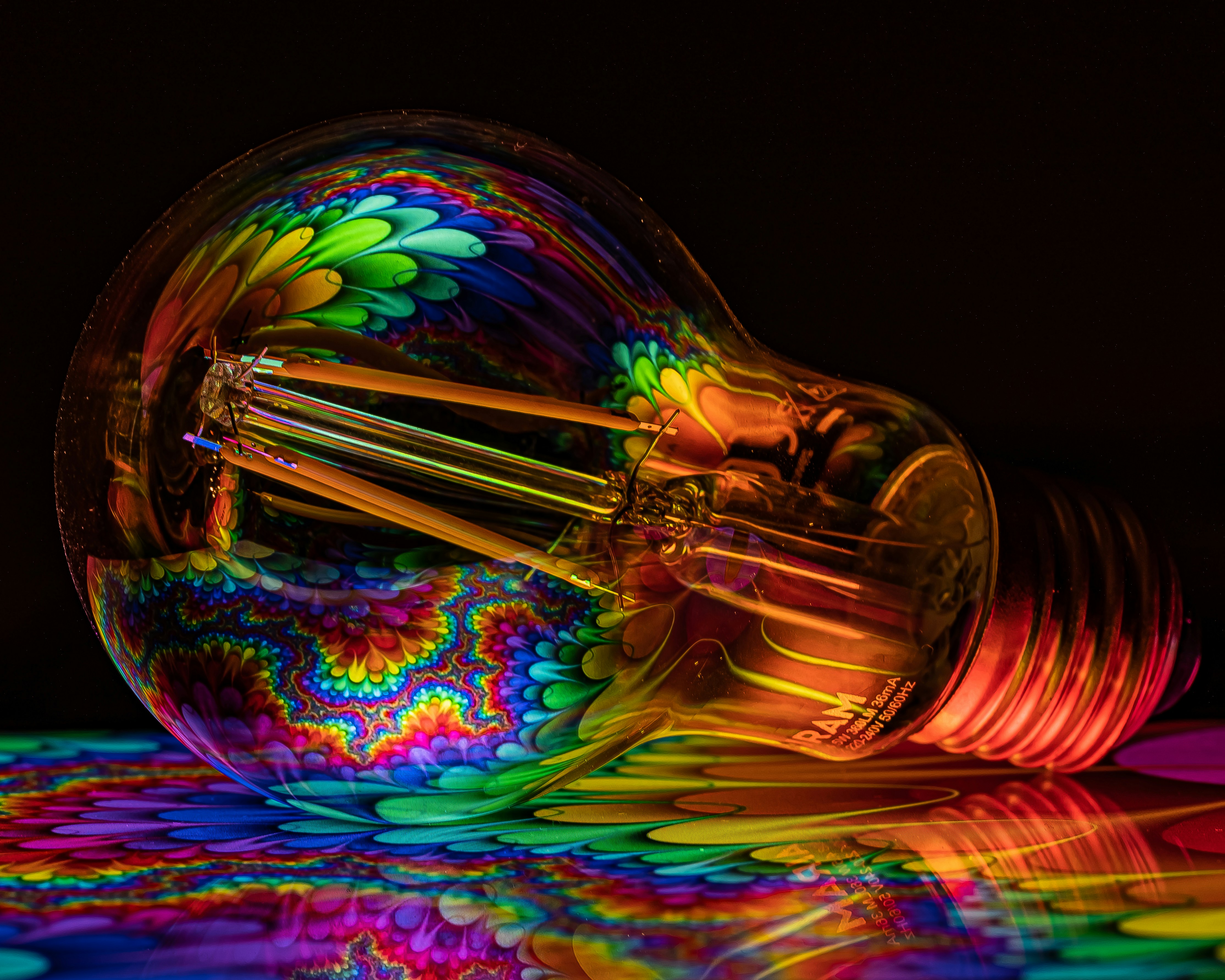 Chromatic Veil: A Glass Bulb Unfurls a Spectrum on a Velvet Surface