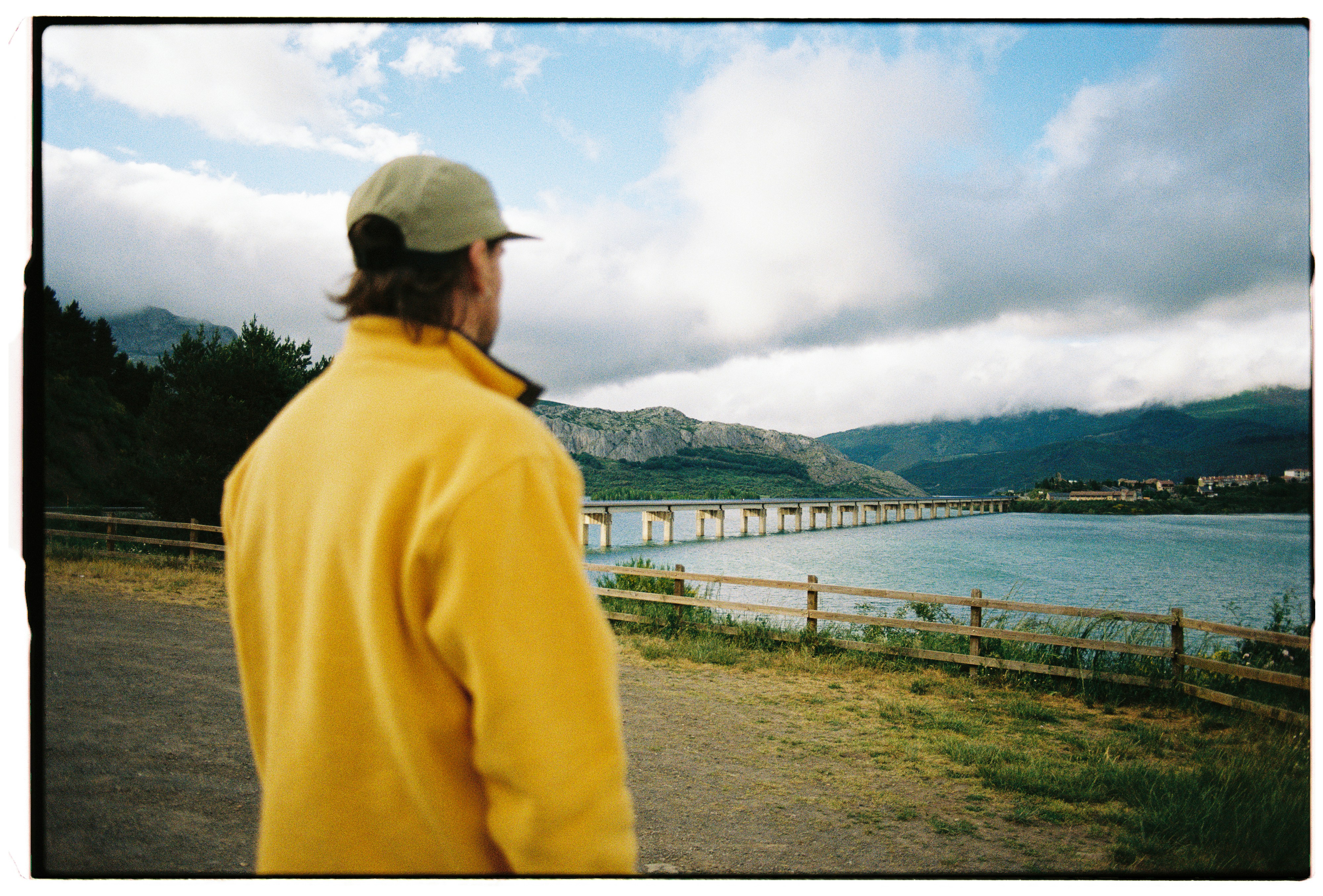 Yellow Jacket by the Shore: A Quiet Frame of a Man in a Hatchback Jacket