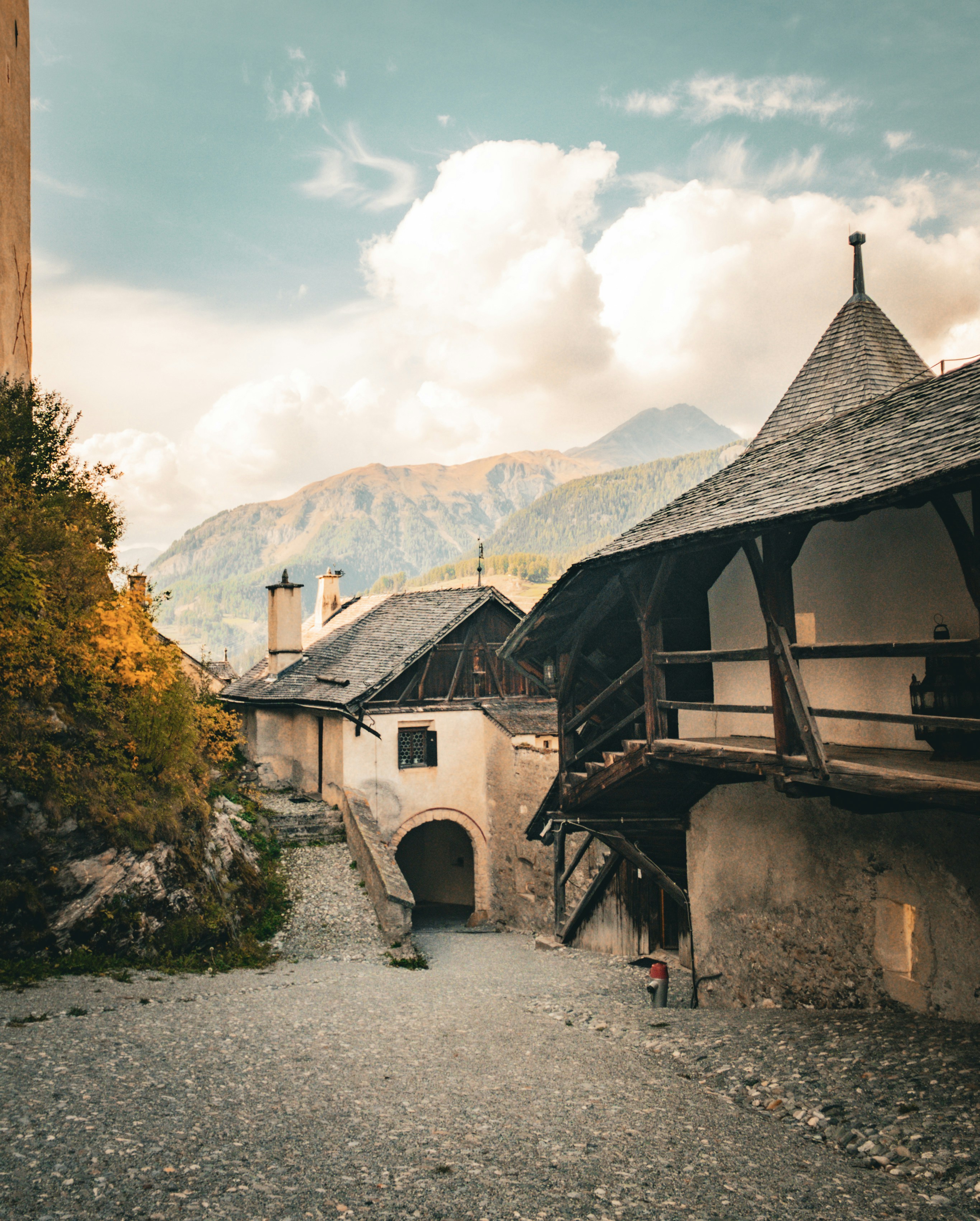 Medieval Village Courtyard under Alpine Sky