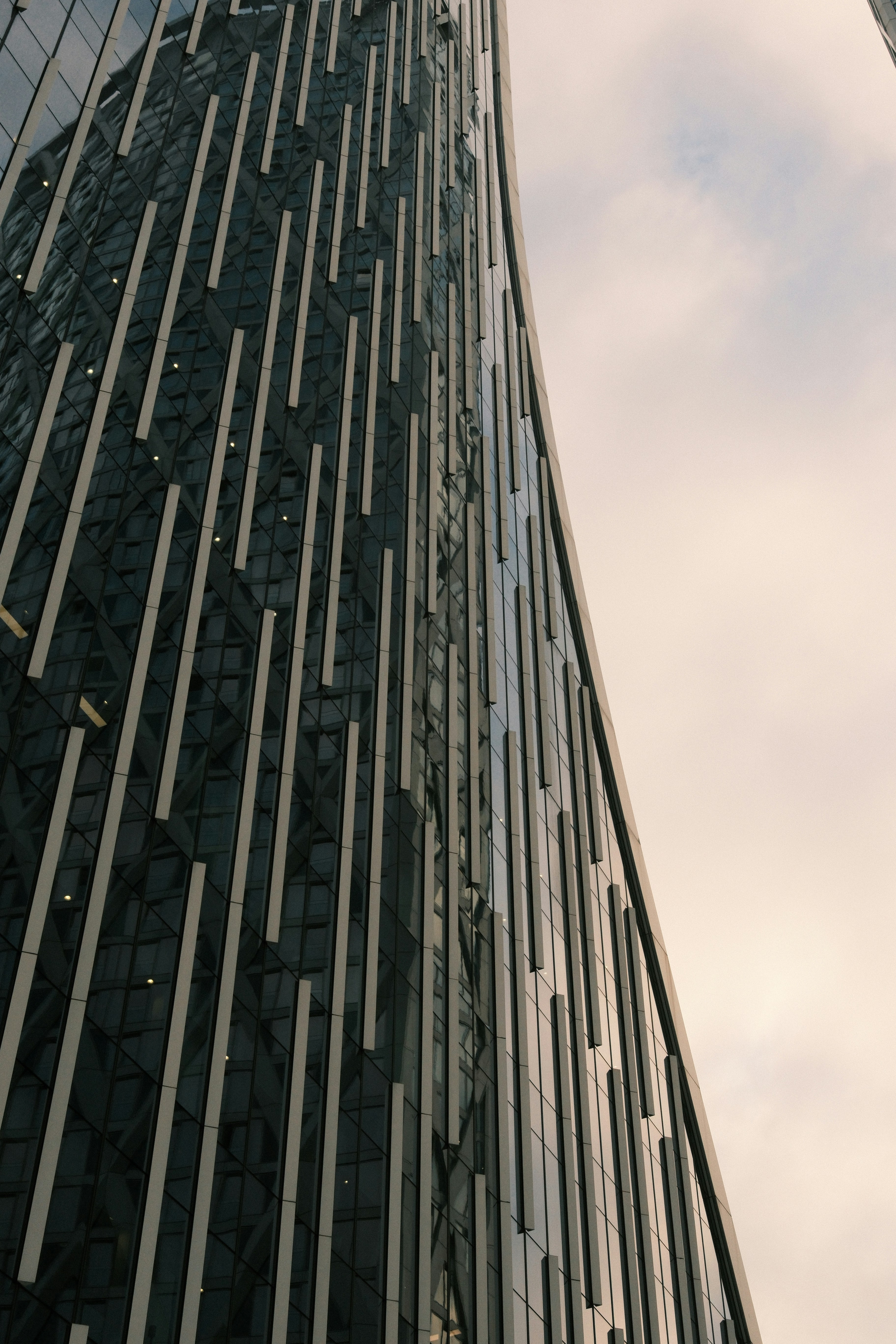 Vertical Facade Echo: A City Highrise Streaked with Glass and Light