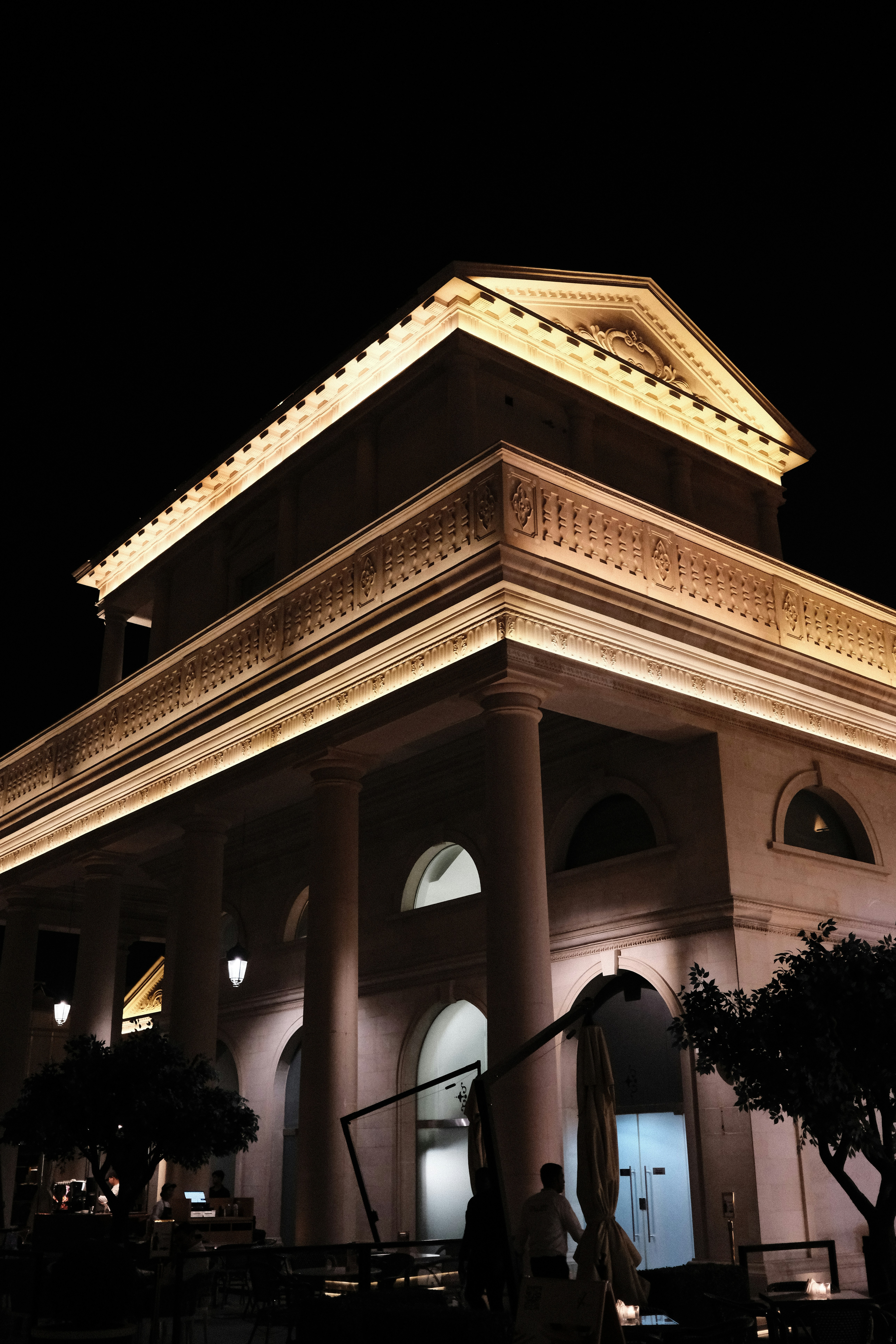 Illuminated Classical Facade Rising from Night